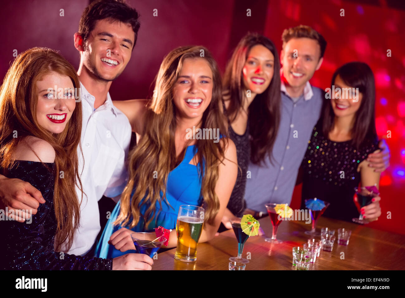 Happy friends on a night out together Stock Photo - Alamy