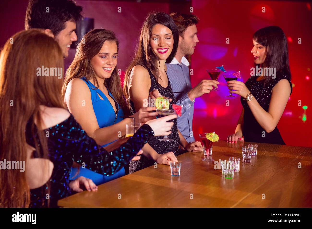 Happy friends on a night out together Stock Photo - Alamy