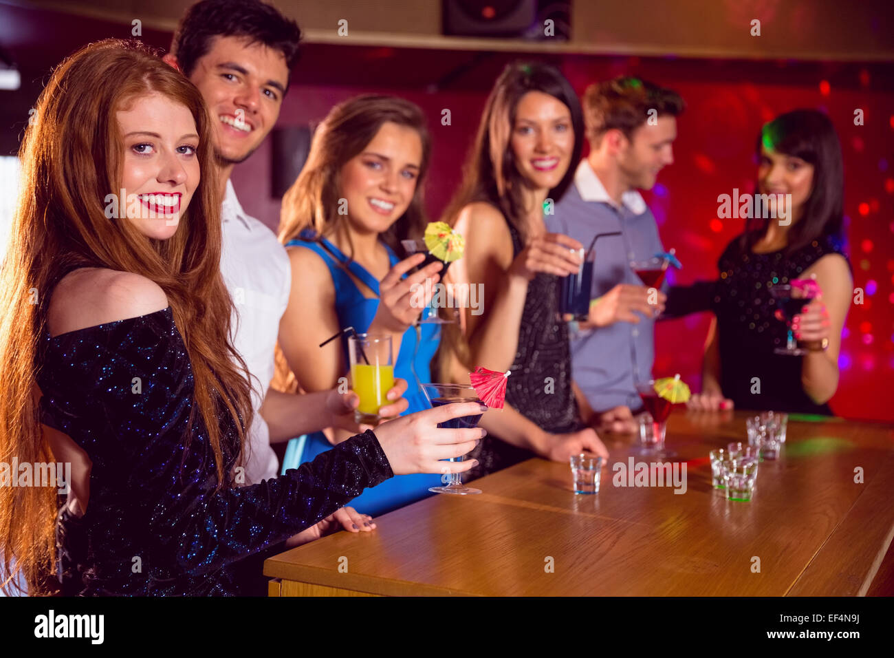 Happy friends on a night out together Stock Photo - Alamy