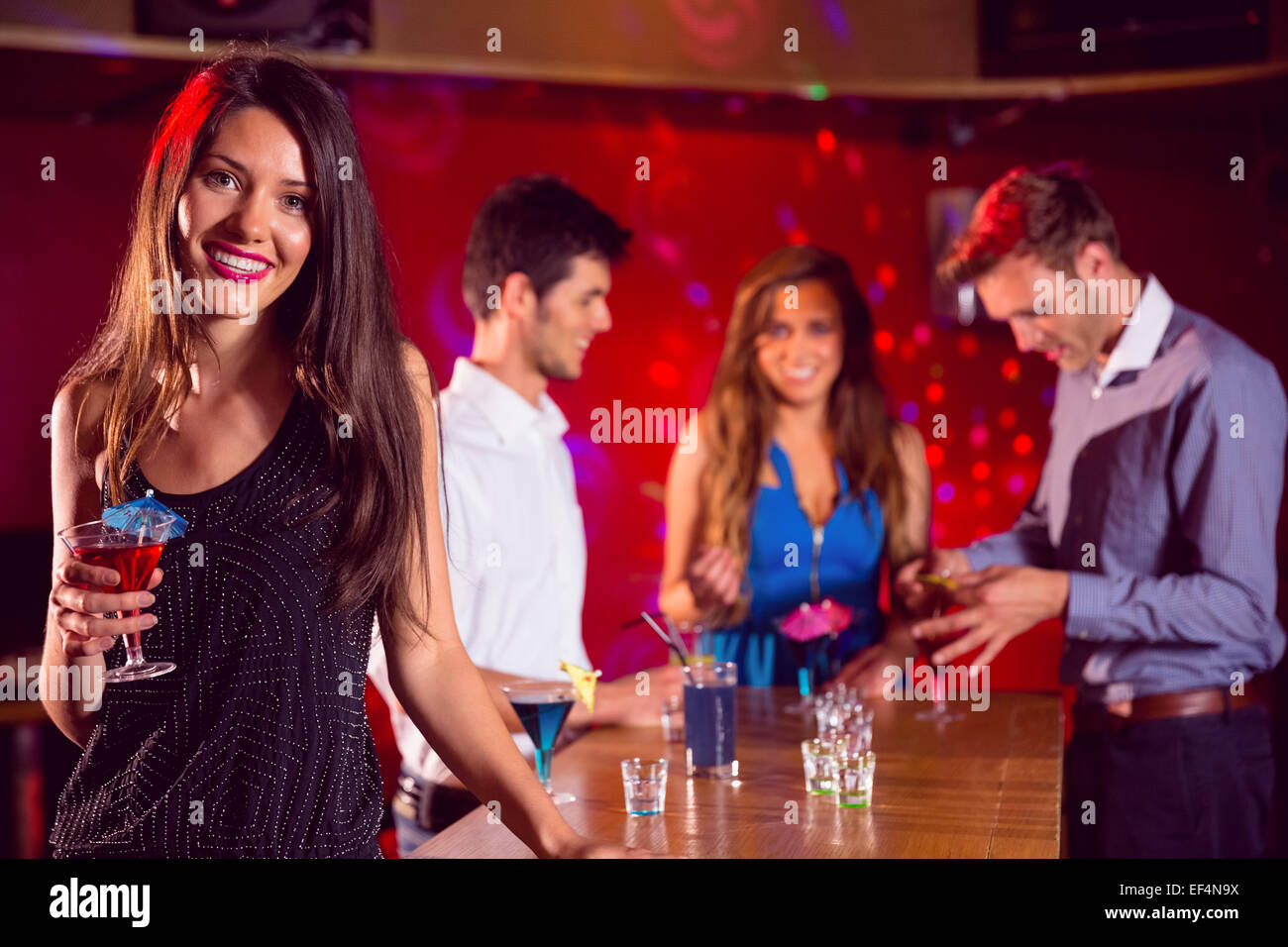 Happy friends on a night out together Stock Photo - Alamy