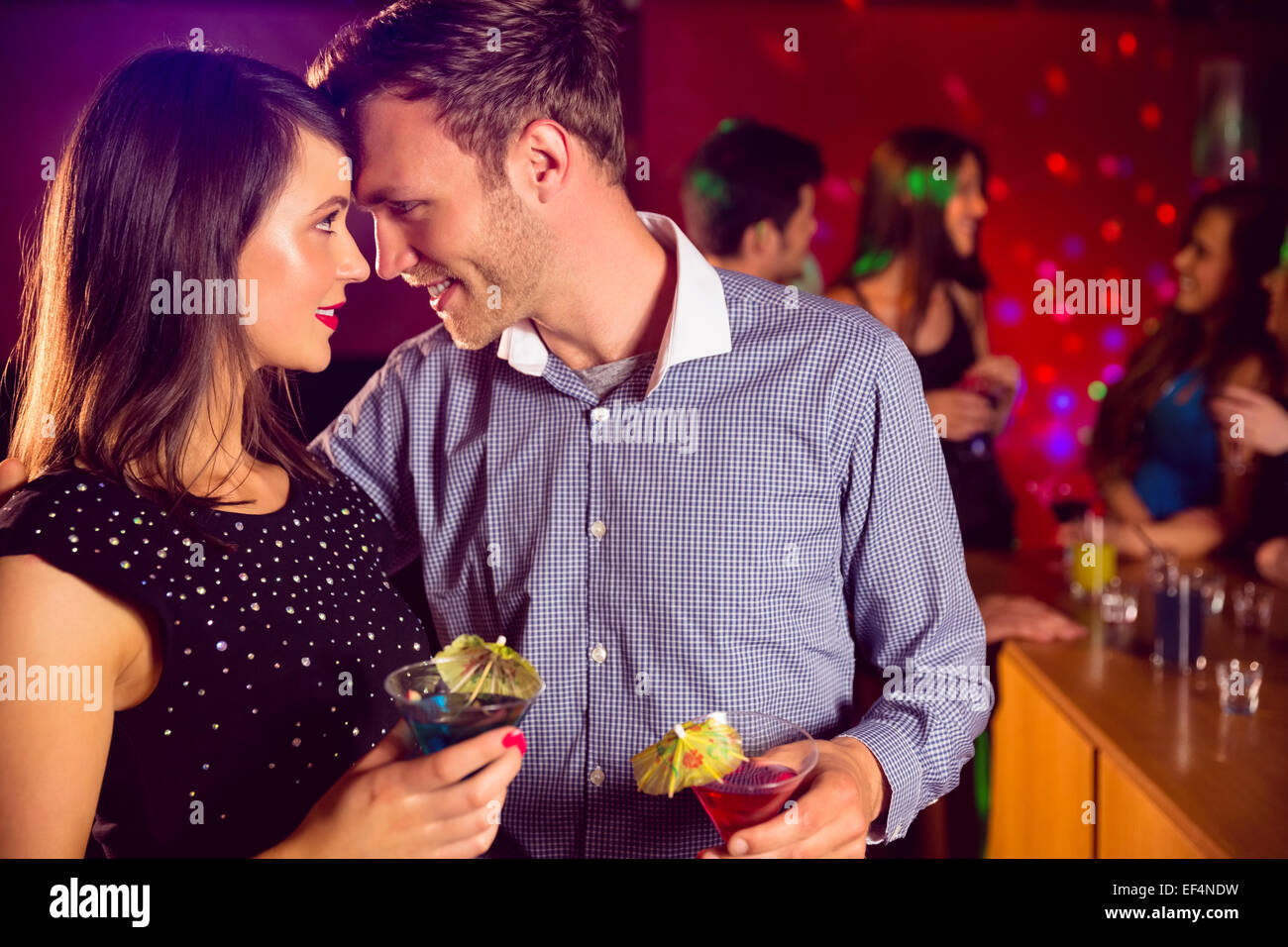 Cute couple drinking cocktails together Stock Photo - Alamy