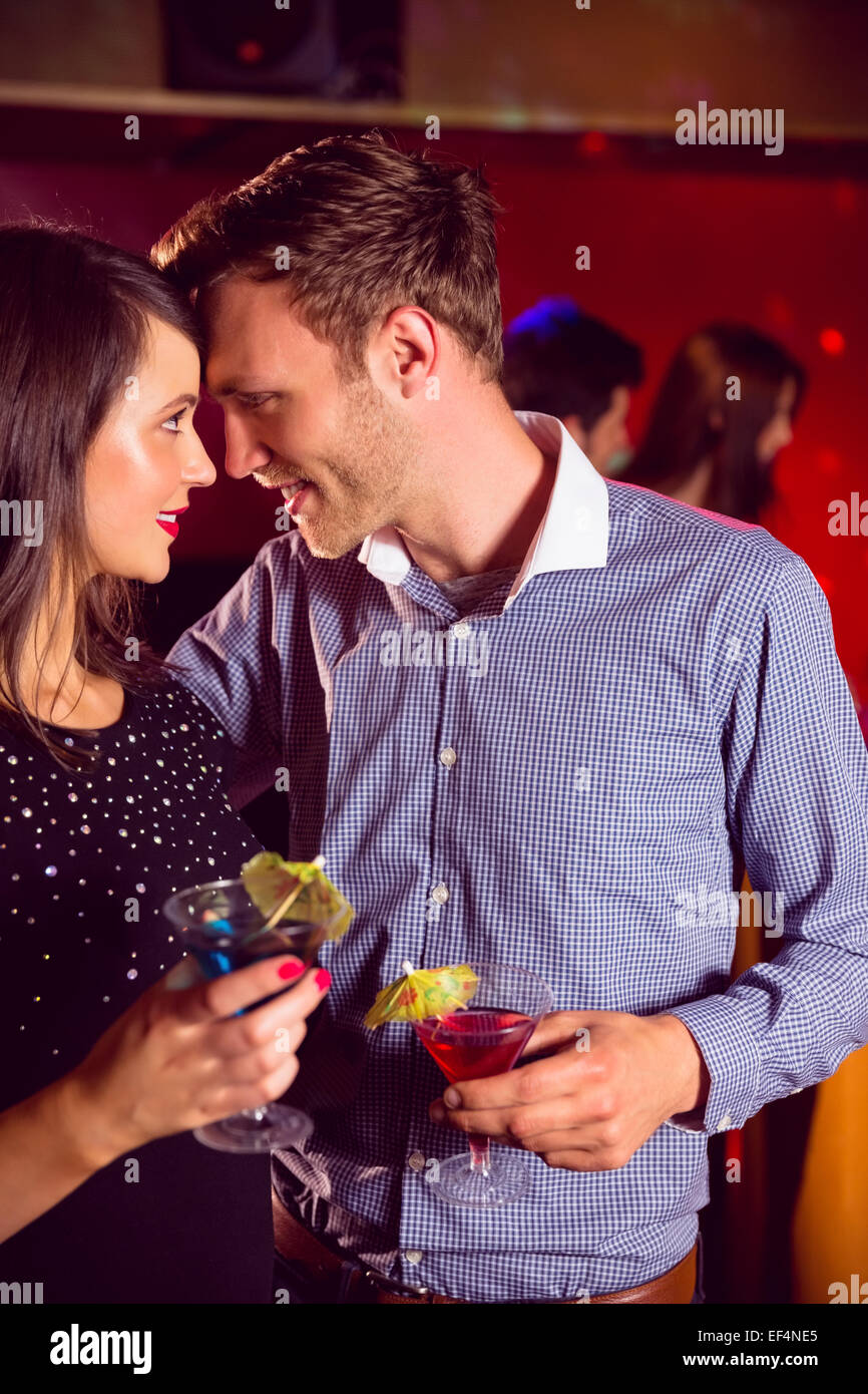 Cute couple drinking cocktails together Stock Photo - Alamy