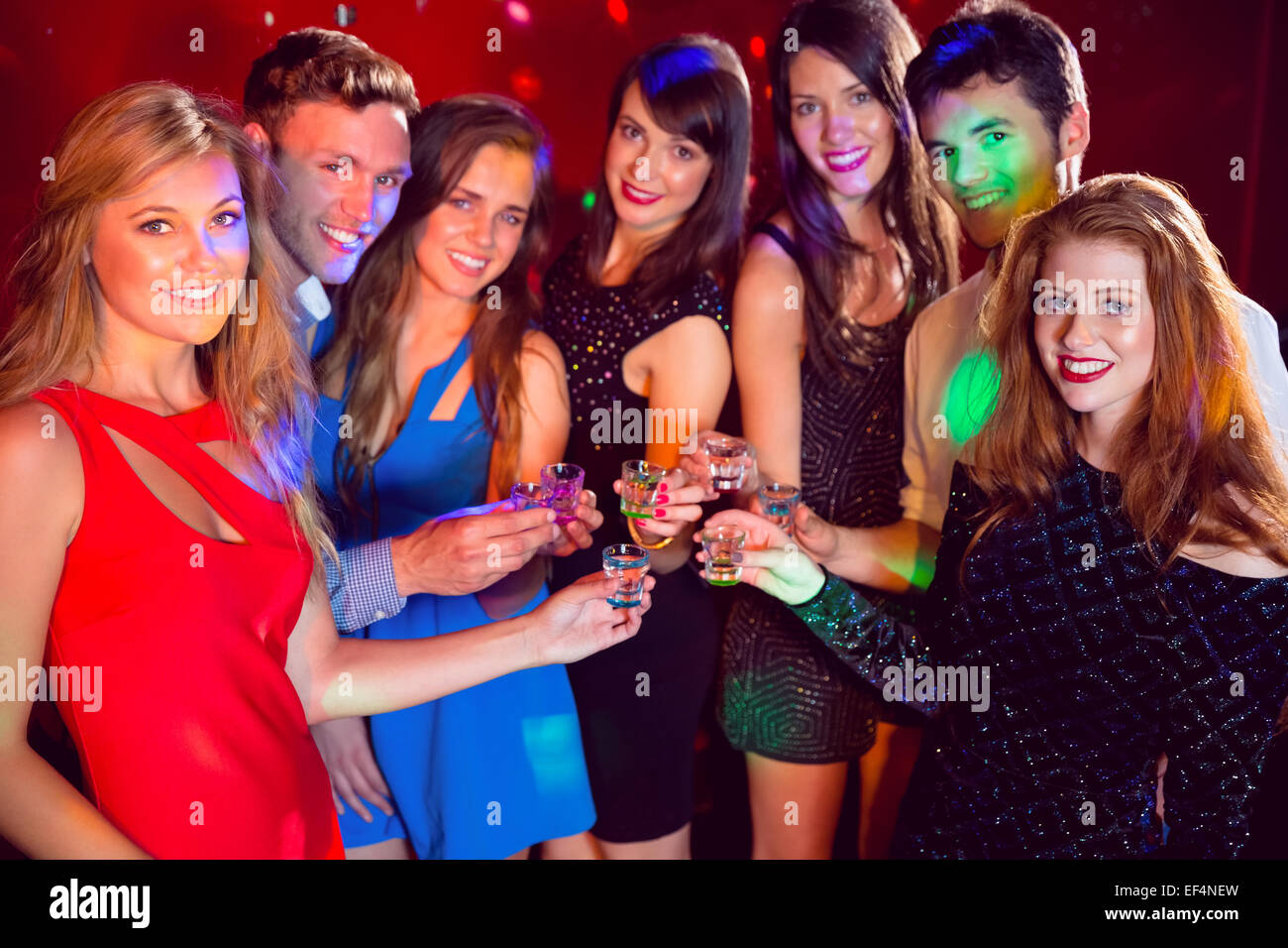 Happy friends on a night out together Stock Photo - Alamy