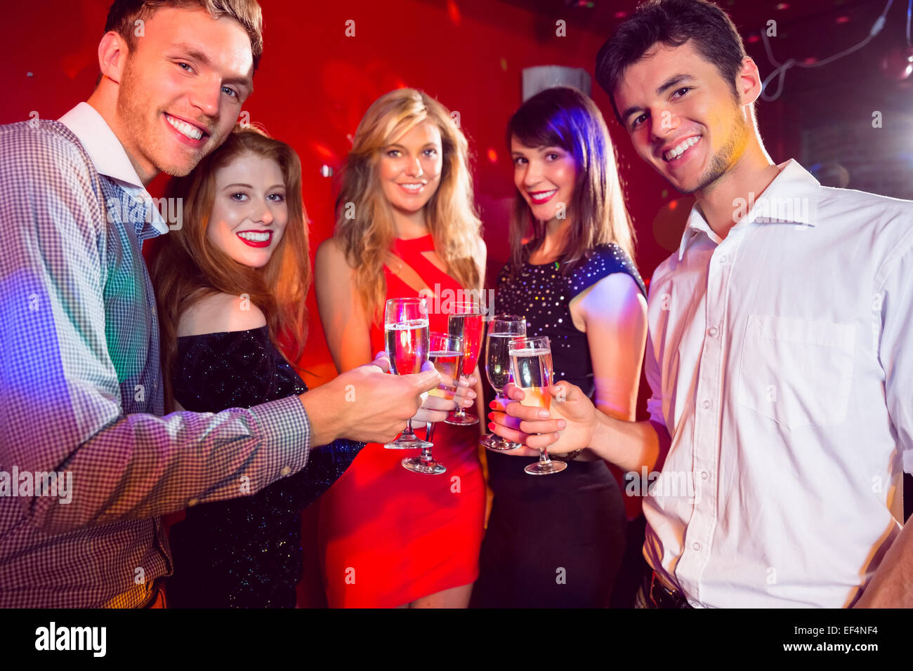 Happy friends on a night out together Stock Photo - Alamy