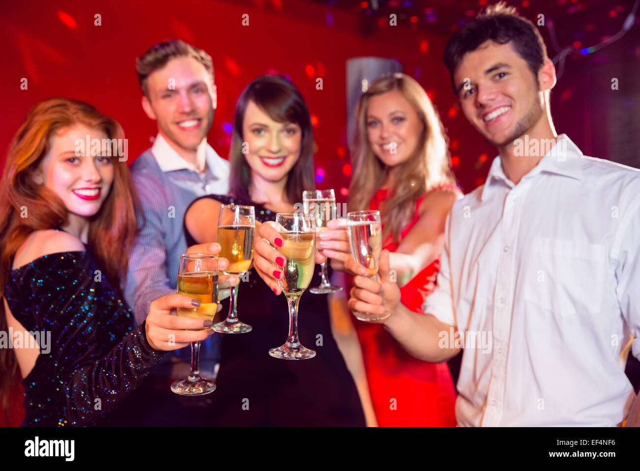 Happy friends on a night out together Stock Photo - Alamy