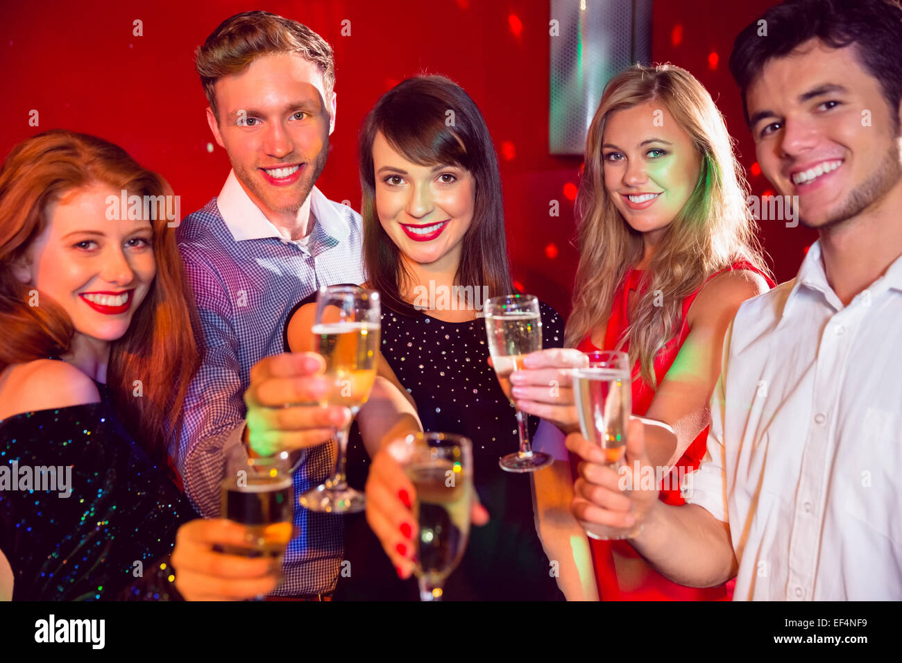 Happy friends on a night out together Stock Photo - Alamy