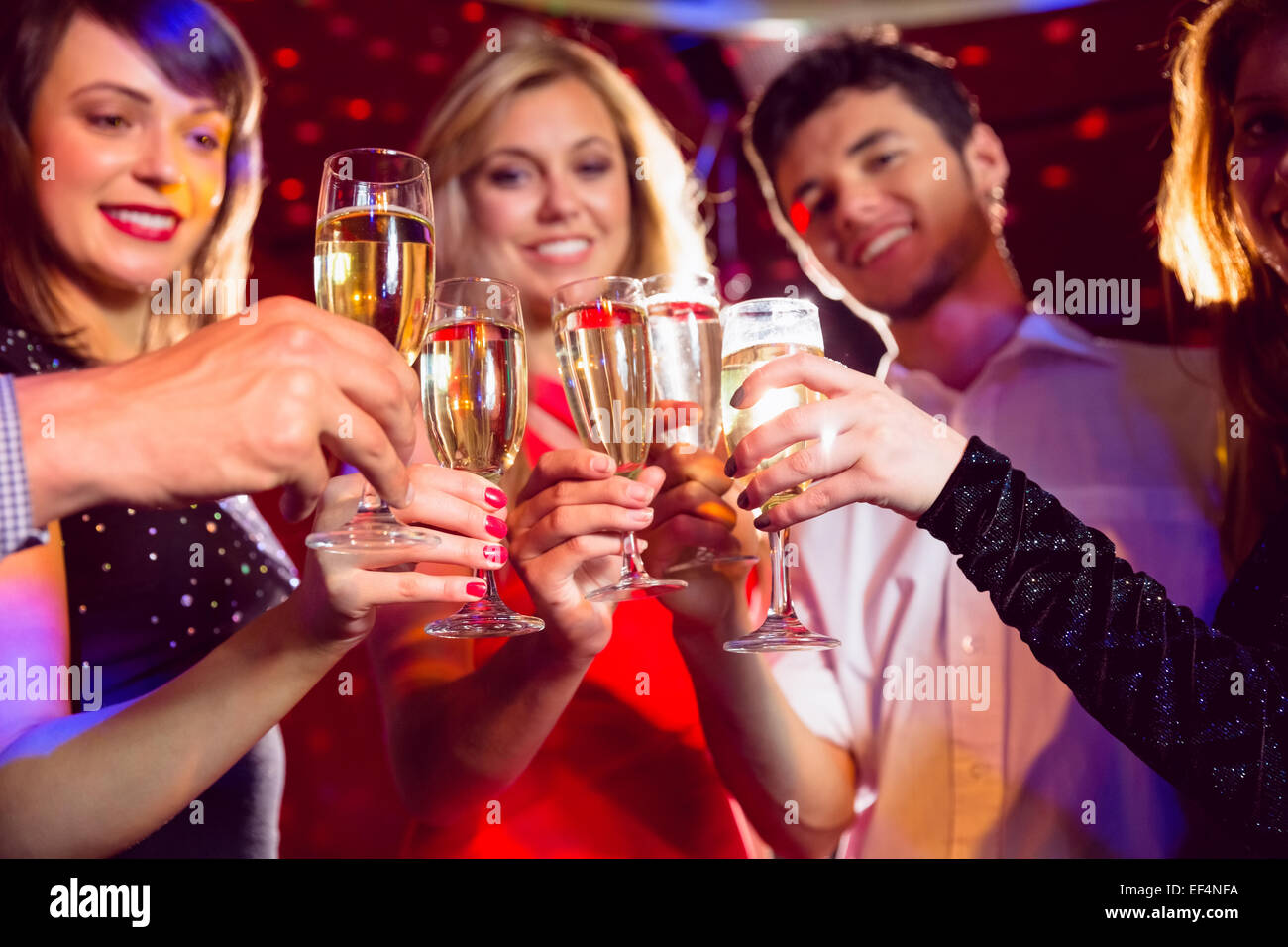Happy friends on a night out together Stock Photo - Alamy