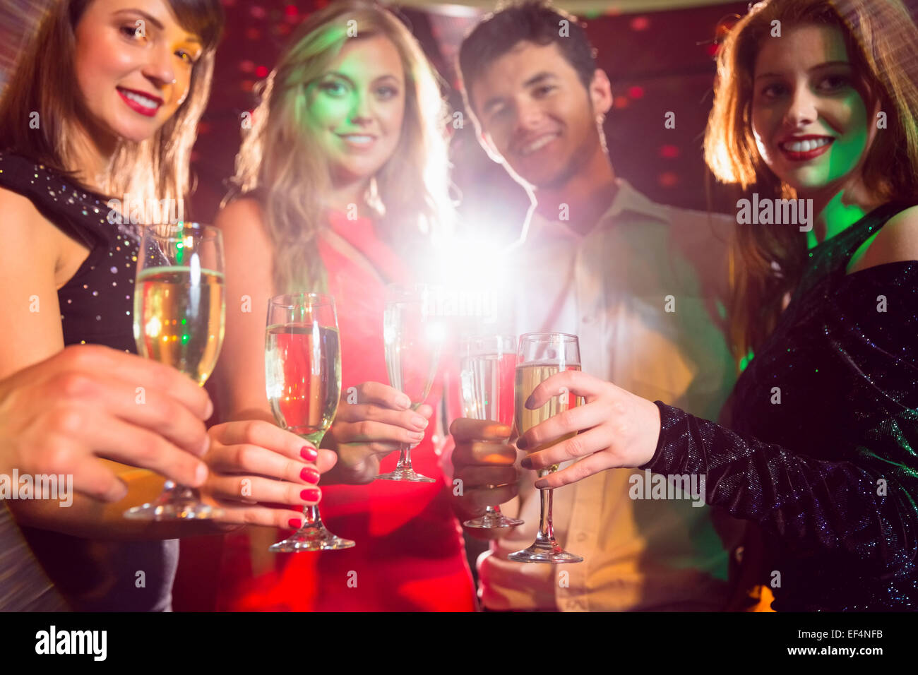 Happy friends on a night out together Stock Photo - Alamy