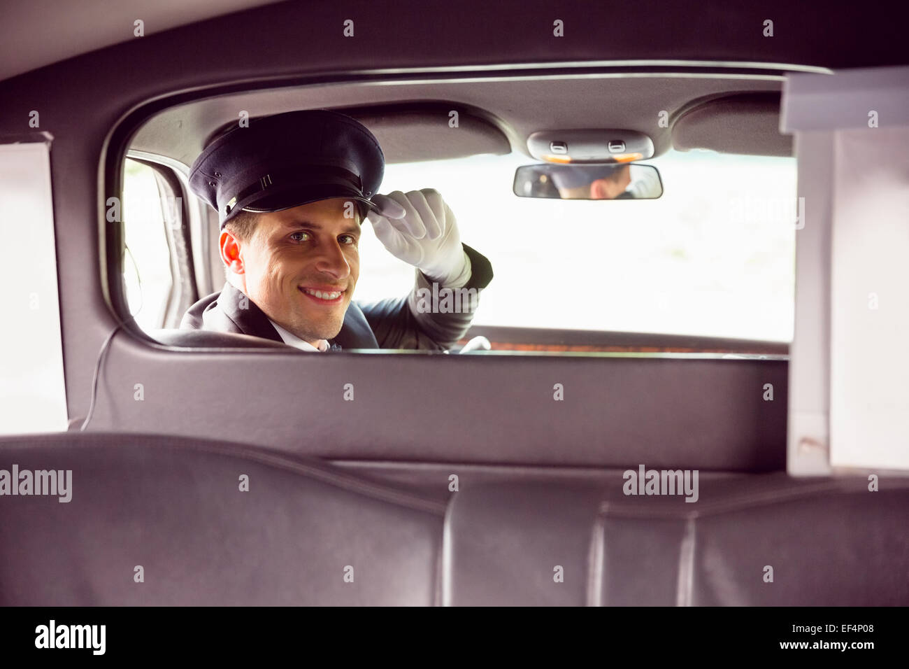 Limousine driver smiling at camera Stock Photo - Alamy