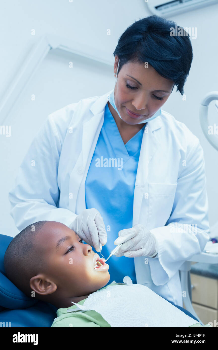Female dentist examining boys teeth Stock Photo - Alamy