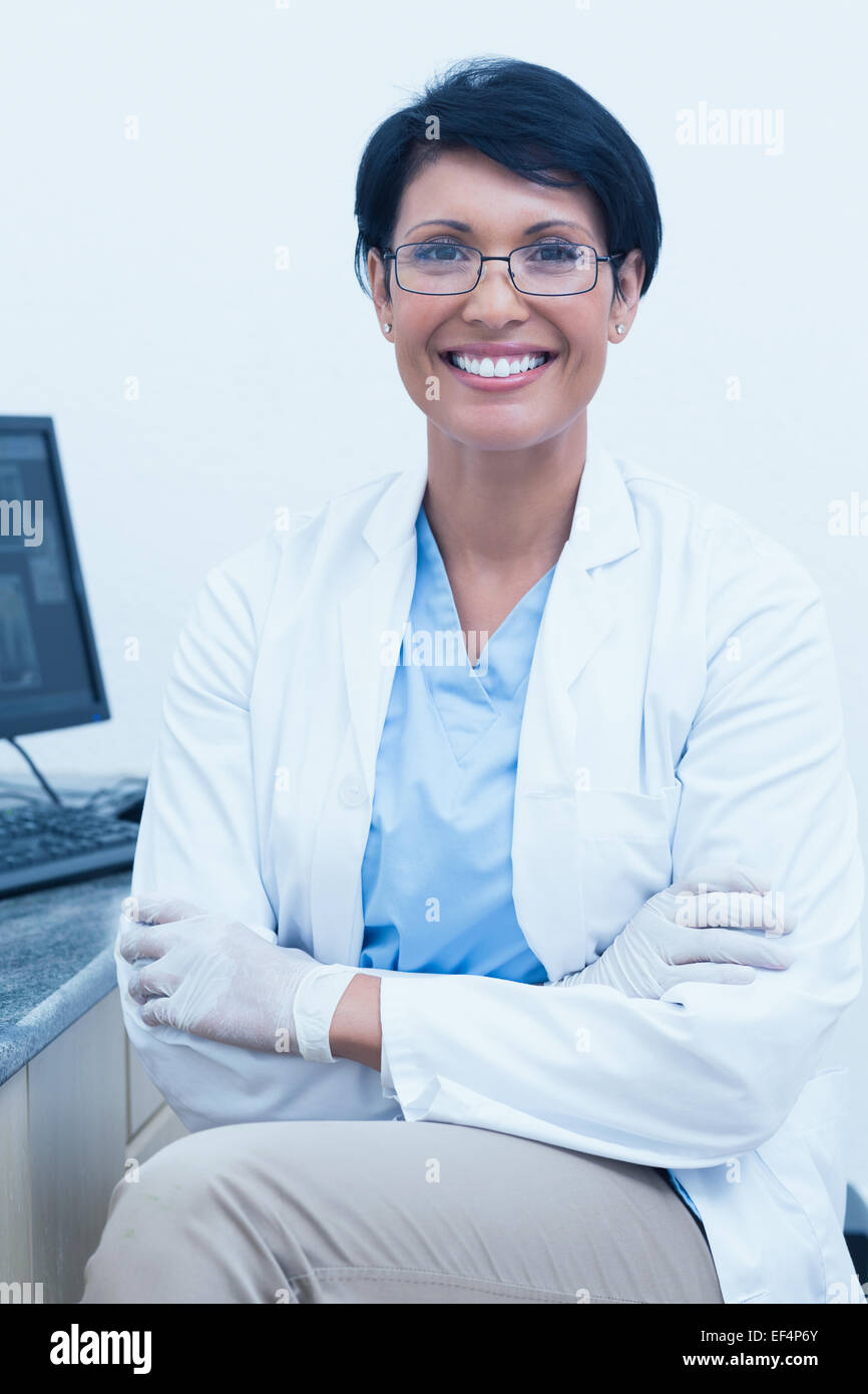Smiling female dentist with arms crossed Stock Photo - Alamy