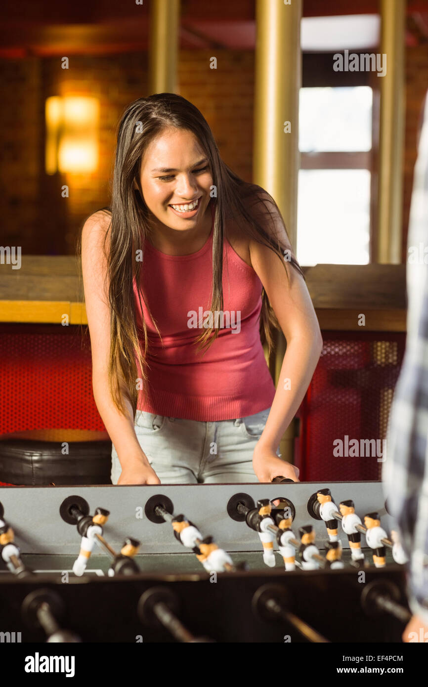 A brunette playing table football Stock Photo - Alamy