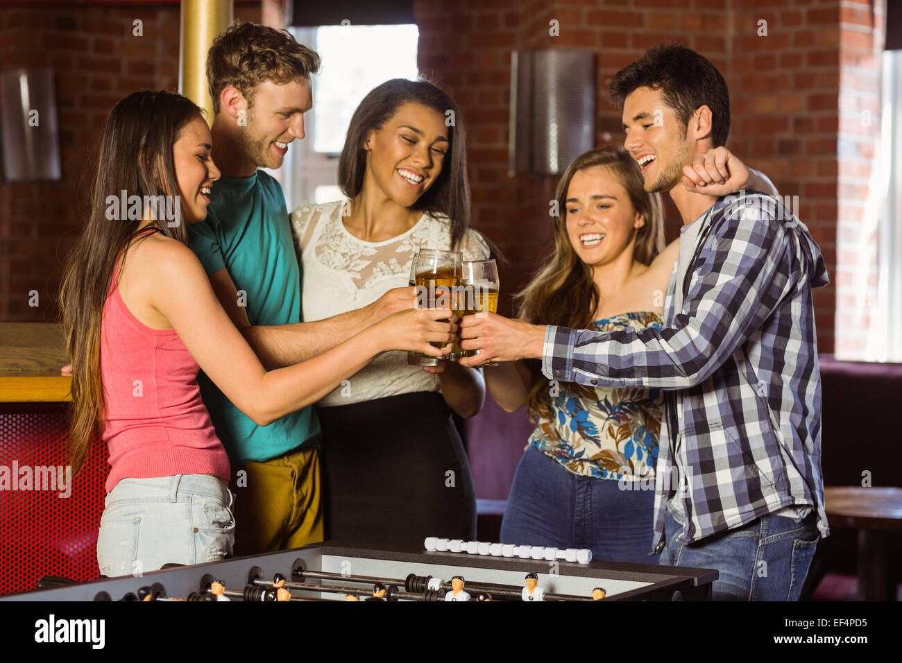 Portrait of happy friends toasting with mixed drink and beer Stock ...