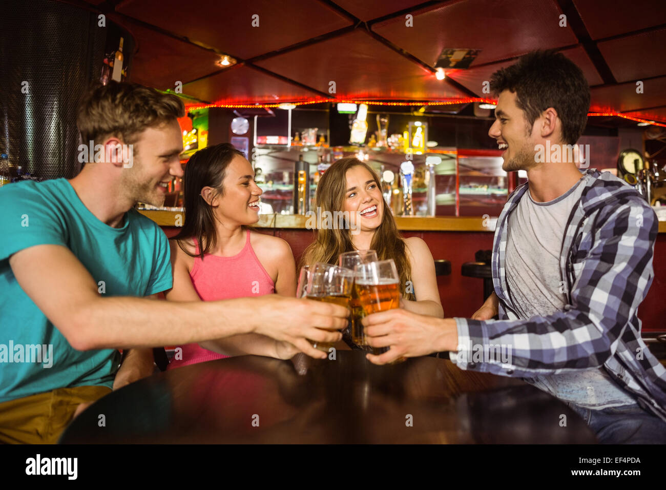 Portrait of happy friends toasting with drink and beer Stock Photo - Alamy