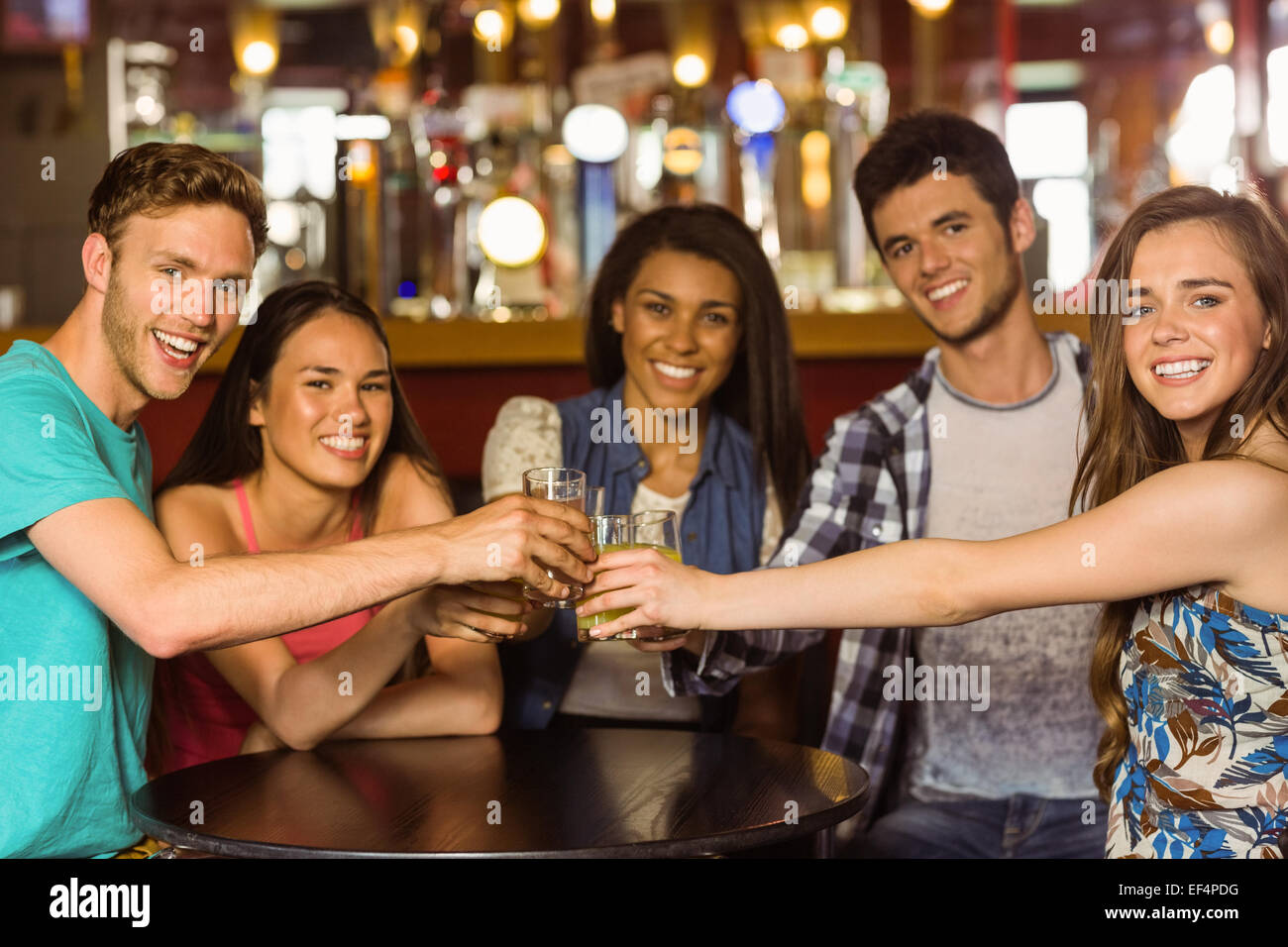 Portrait of happy friends toasting with drink and beer Stock Photo - Alamy