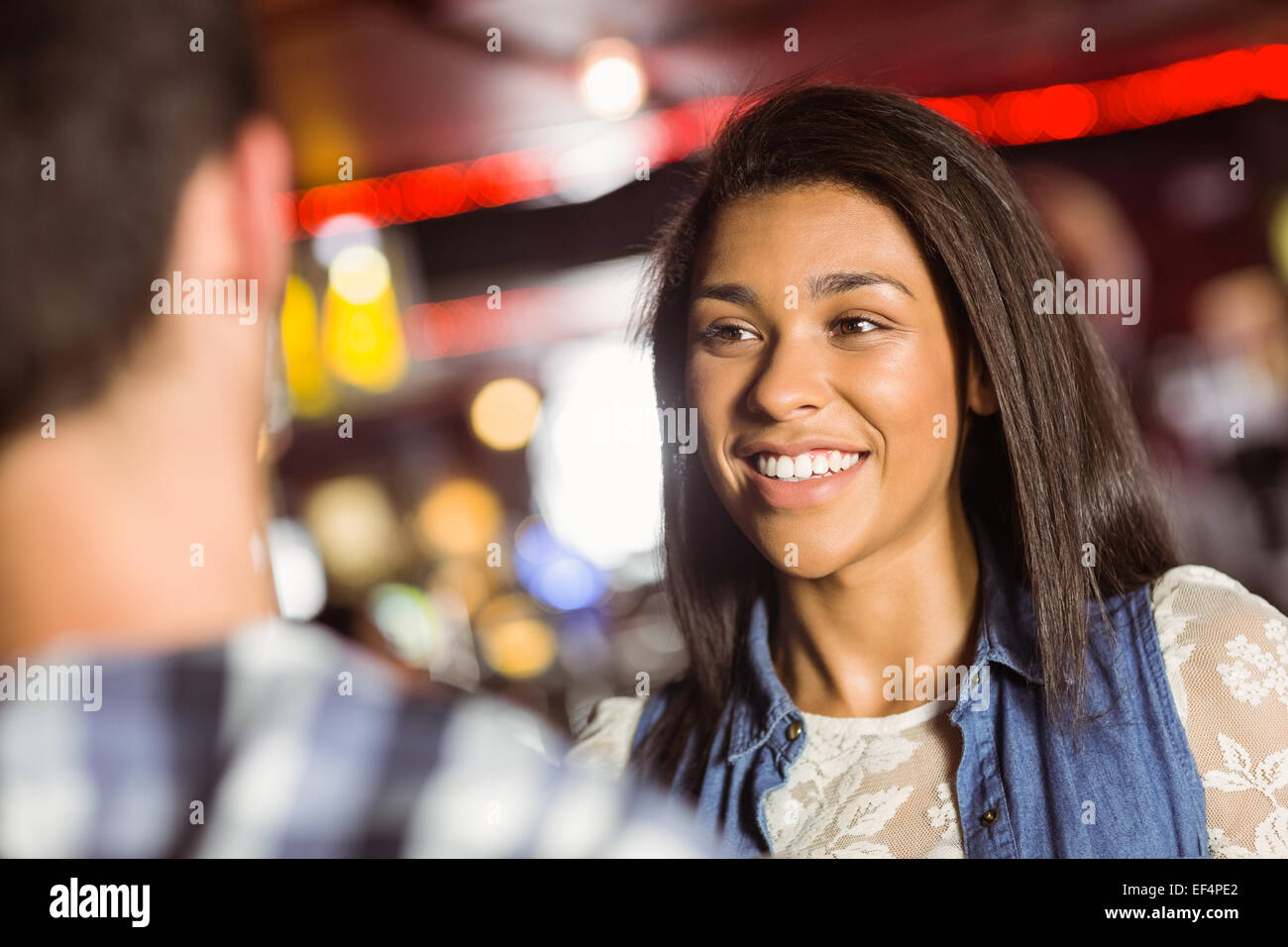 Happy friends standing chatting together Stock Photo - Alamy