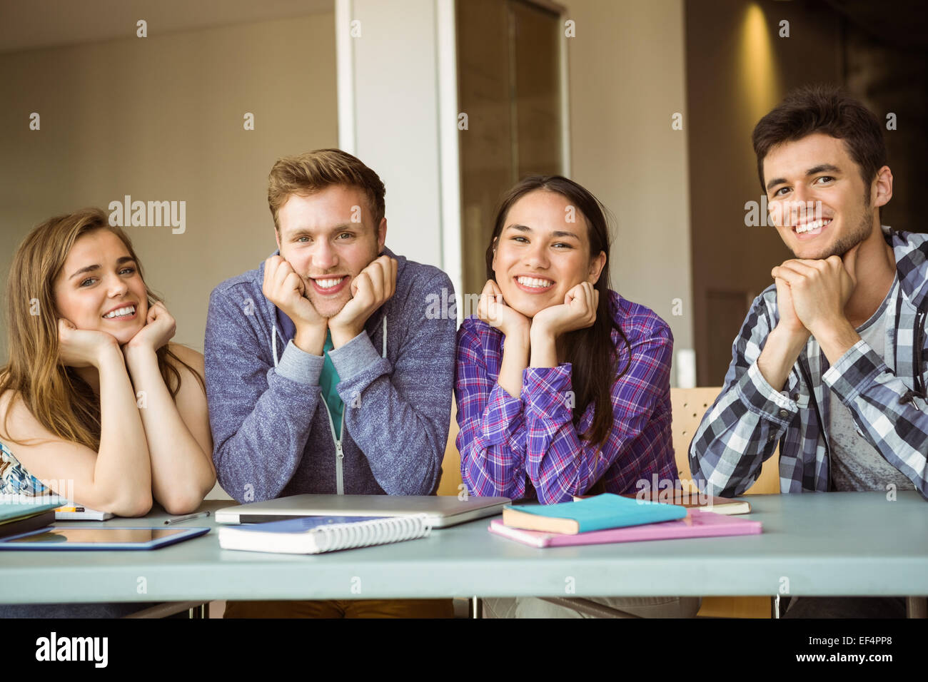 Smiling students studying together and look at camera Stock Photo - Alamy