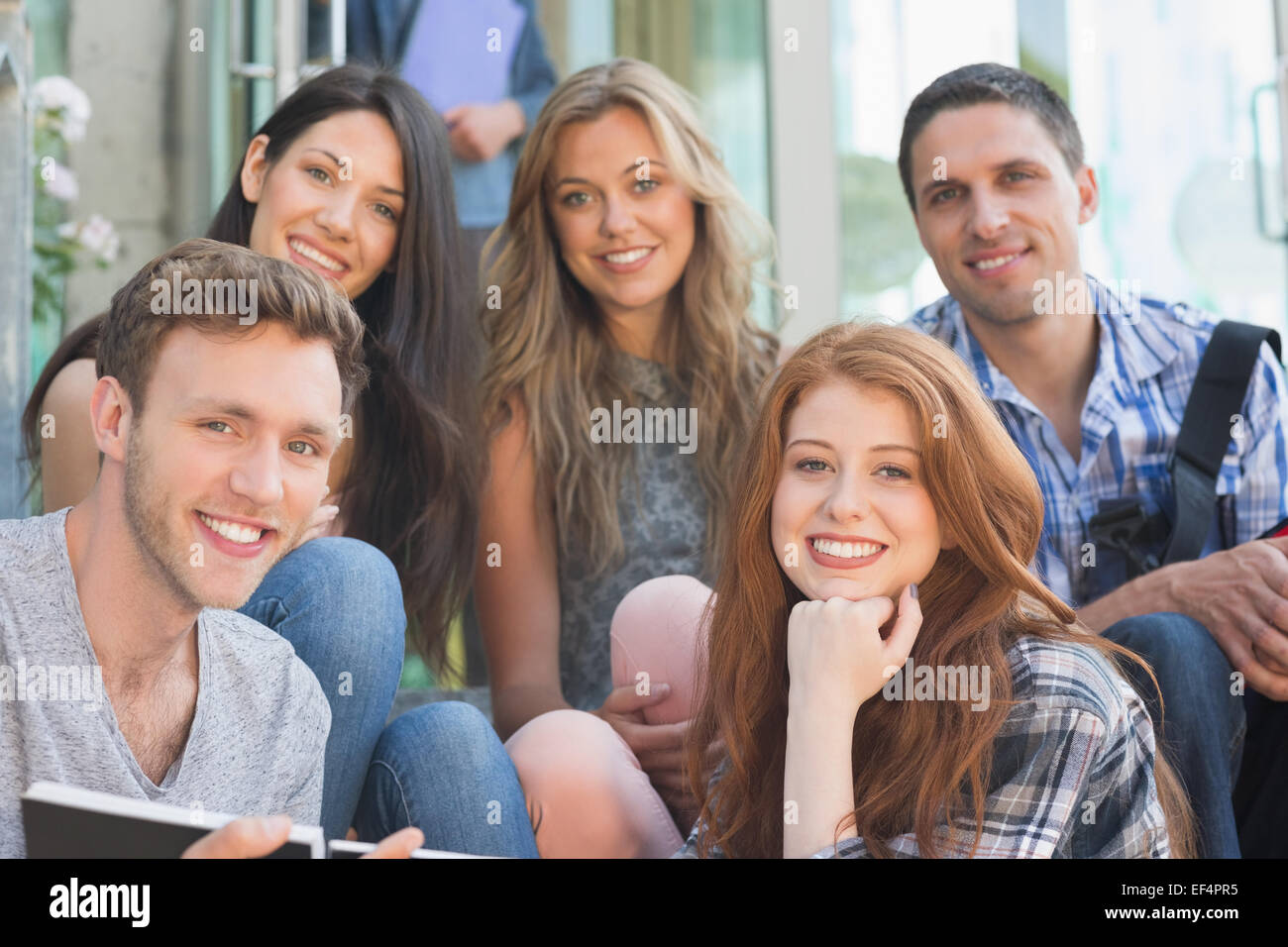 Happy students smiling at camera outside on campus Stock Photo - Alamy