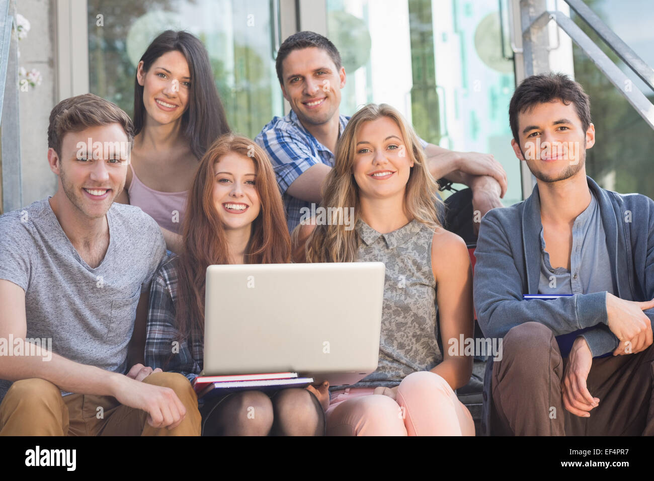Happy students smiling at camera outside on campus Stock Photo - Alamy
