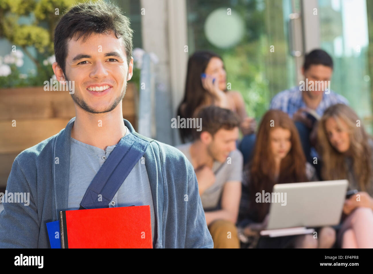 Happy student smiling at camera outside on campus Stock Photo - Alamy