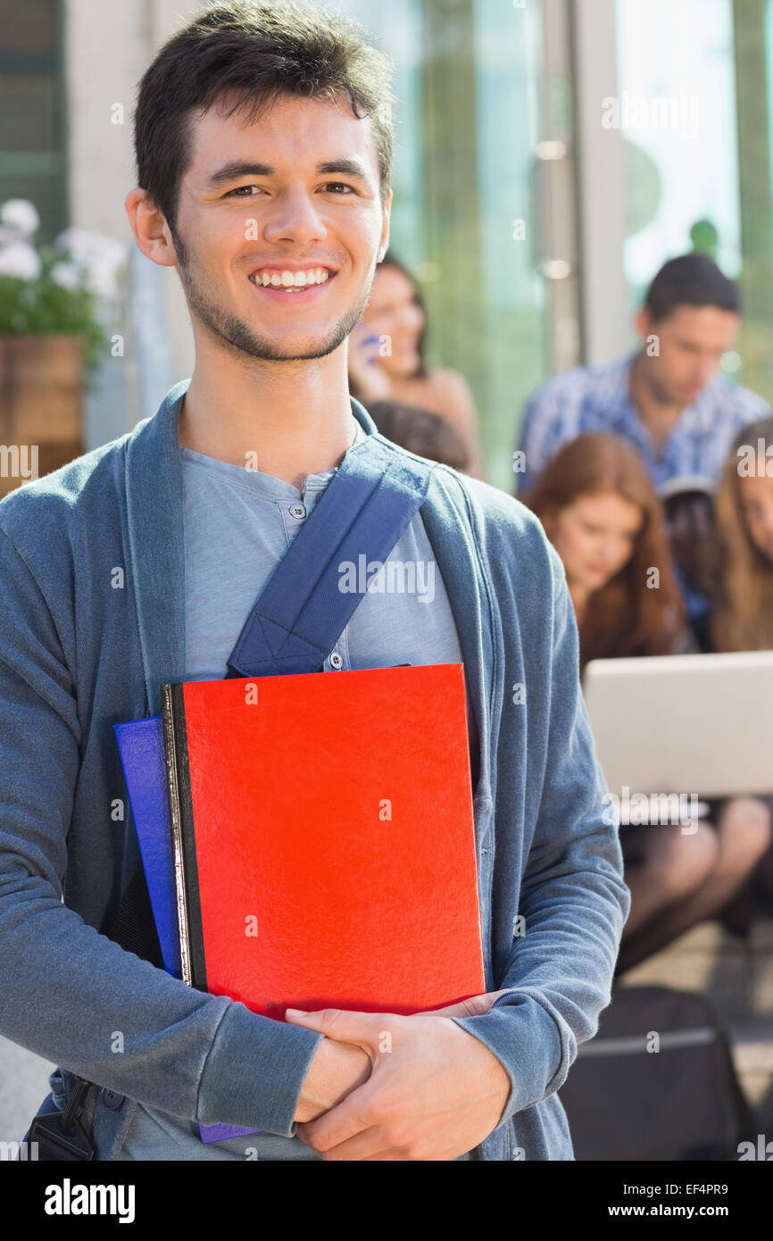 Happy student smiling at camera outside on campus Stock Photo - Alamy