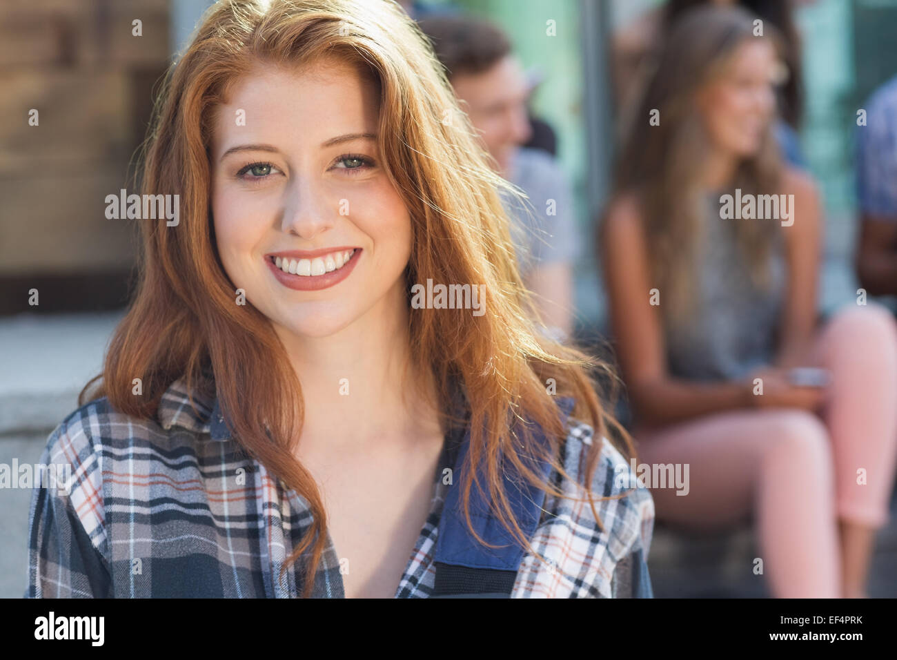 Pretty student smiling at camera outside Stock Photo - Alamy