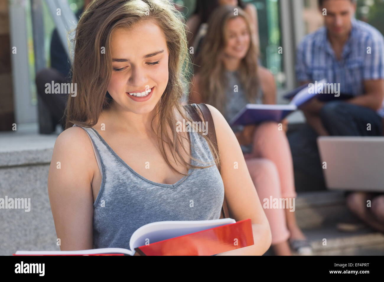 Male student reading notepad outdoors hi-res stock photography and images - Alamy