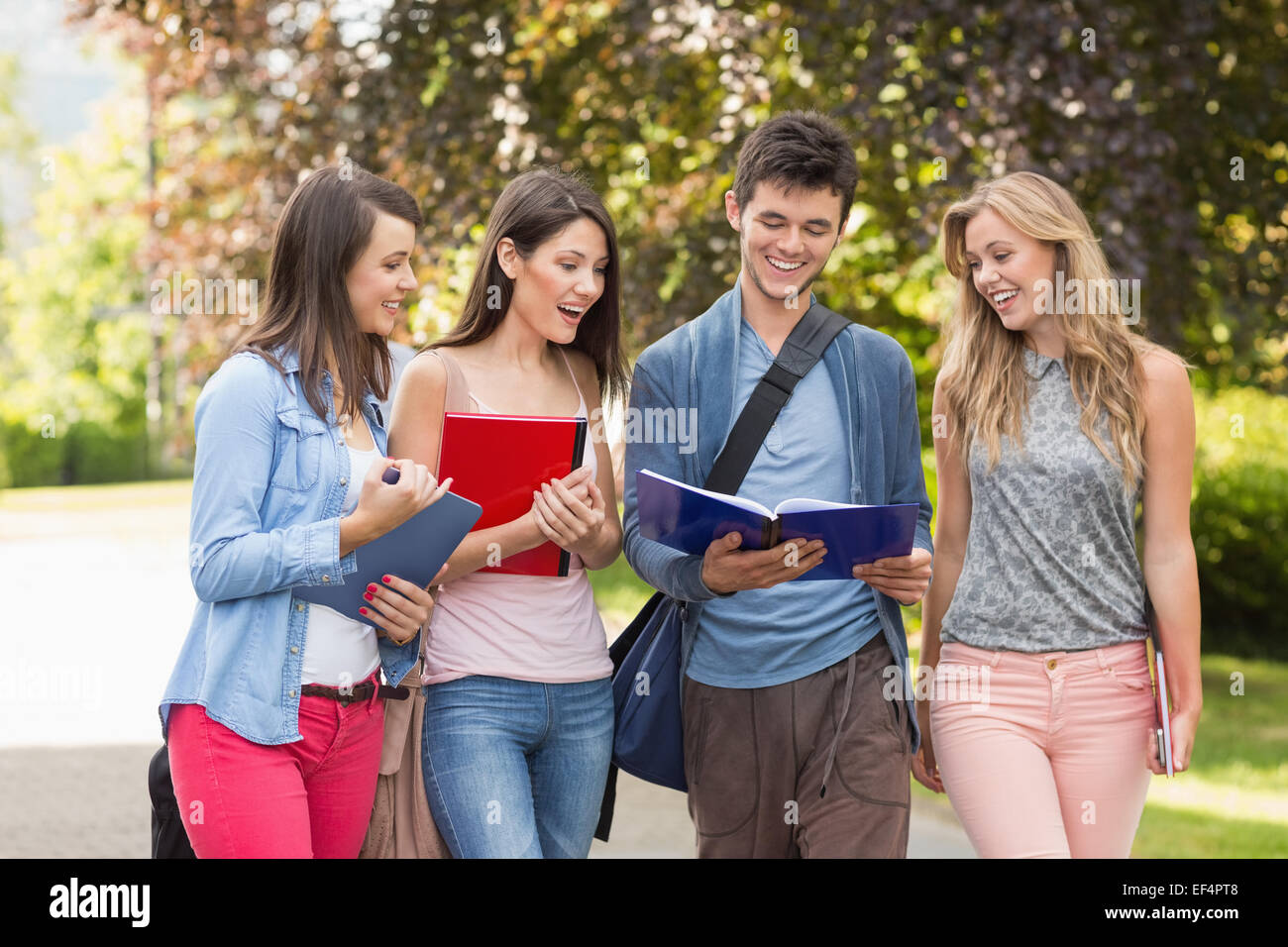 Happy students walking and chatting outside Stock Photo - Alamy