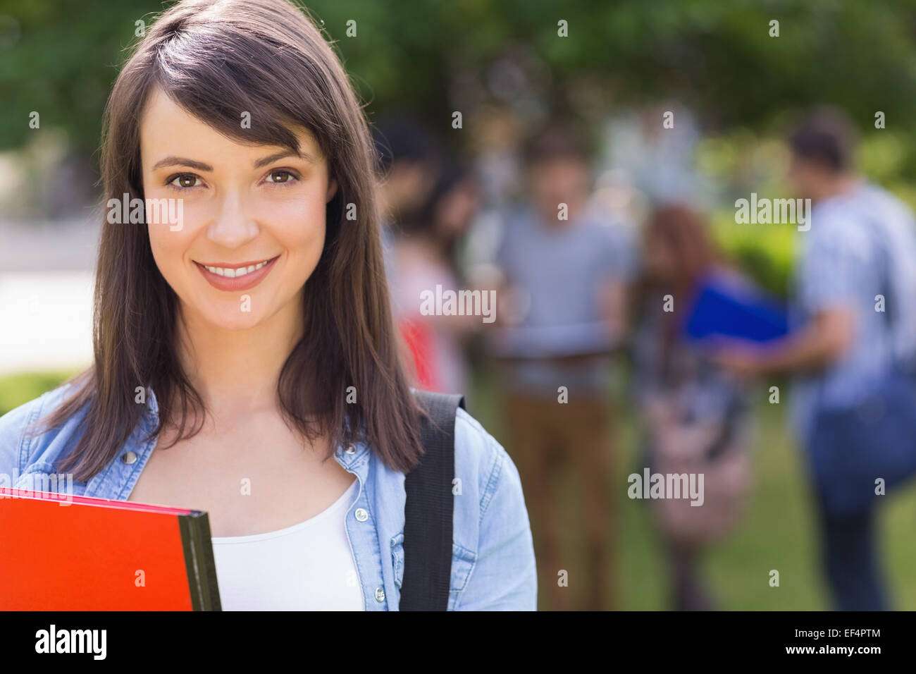 Pretty student smiling at camera outside on campus Stock Photo - Alamy