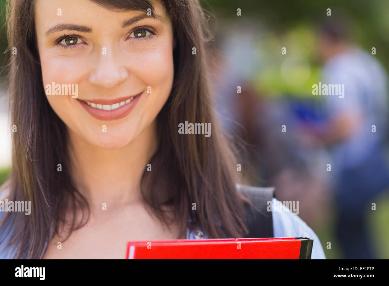 Pretty student smiling at camera outside on campus Stock Photo - Alamy