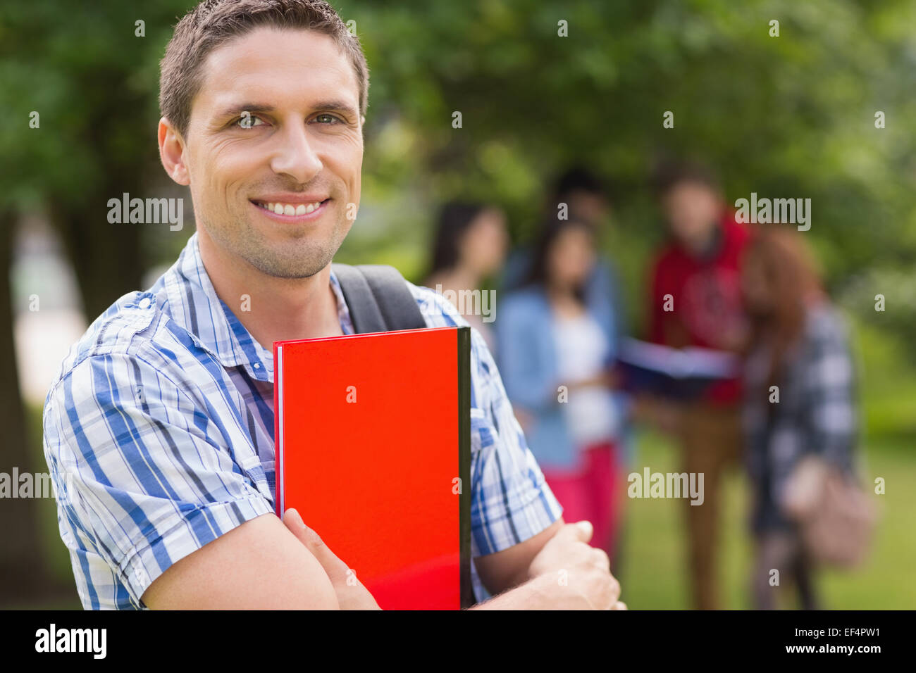 Happy student smiling at camera outside on campus Stock Photo - Alamy