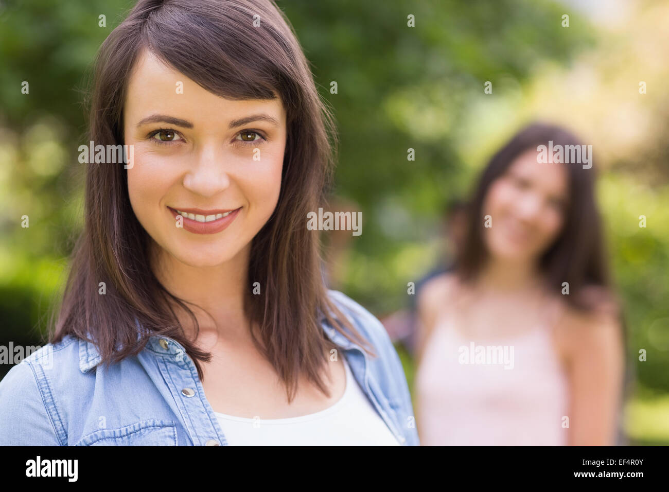 Pretty student smiling at camera outside on campus Stock Photo - Alamy