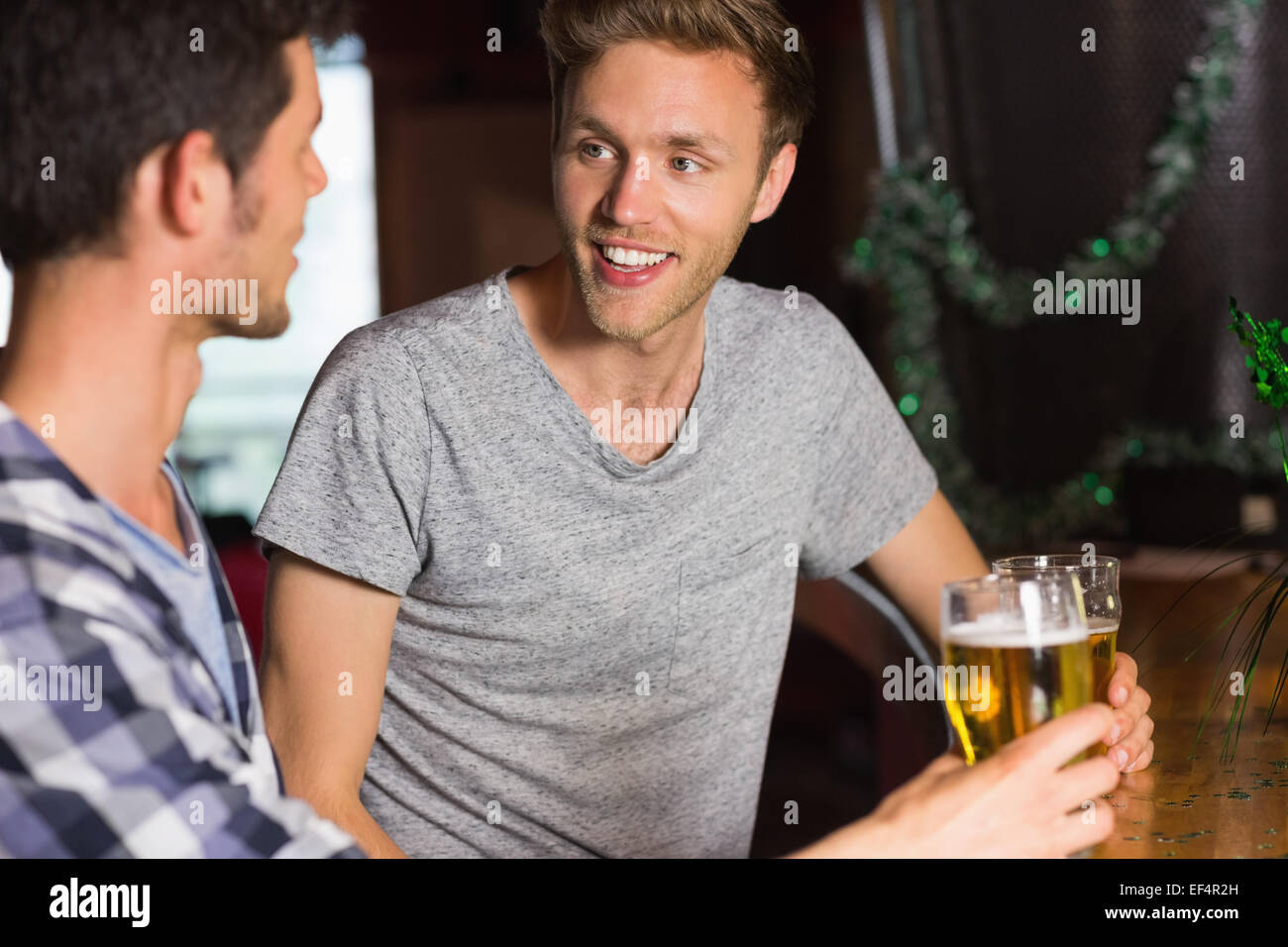 Happy friends catching up over pints Stock Photo - Alamy
