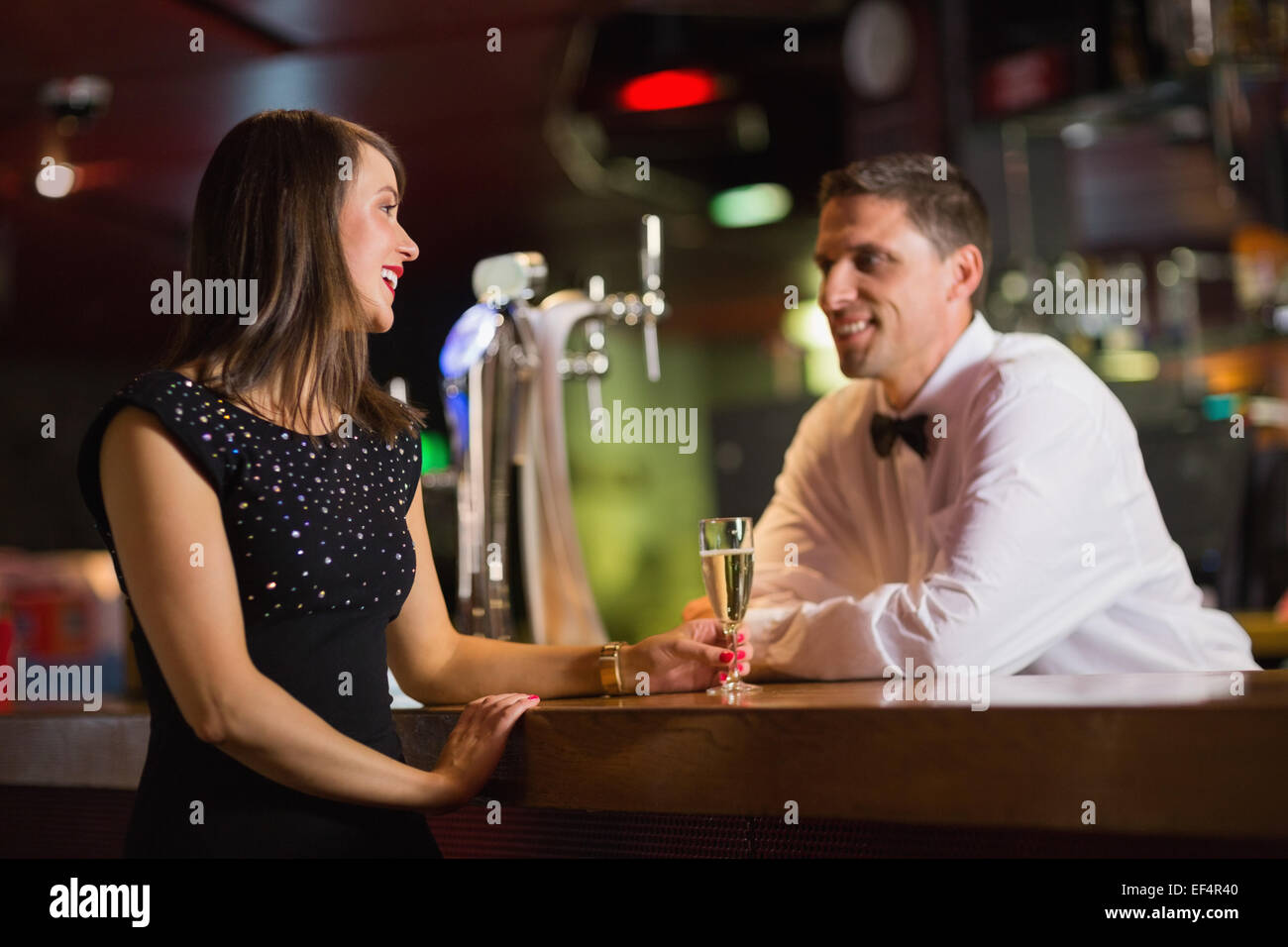 Handsome barman serving champagne to customer Stock Photo - Alamy
