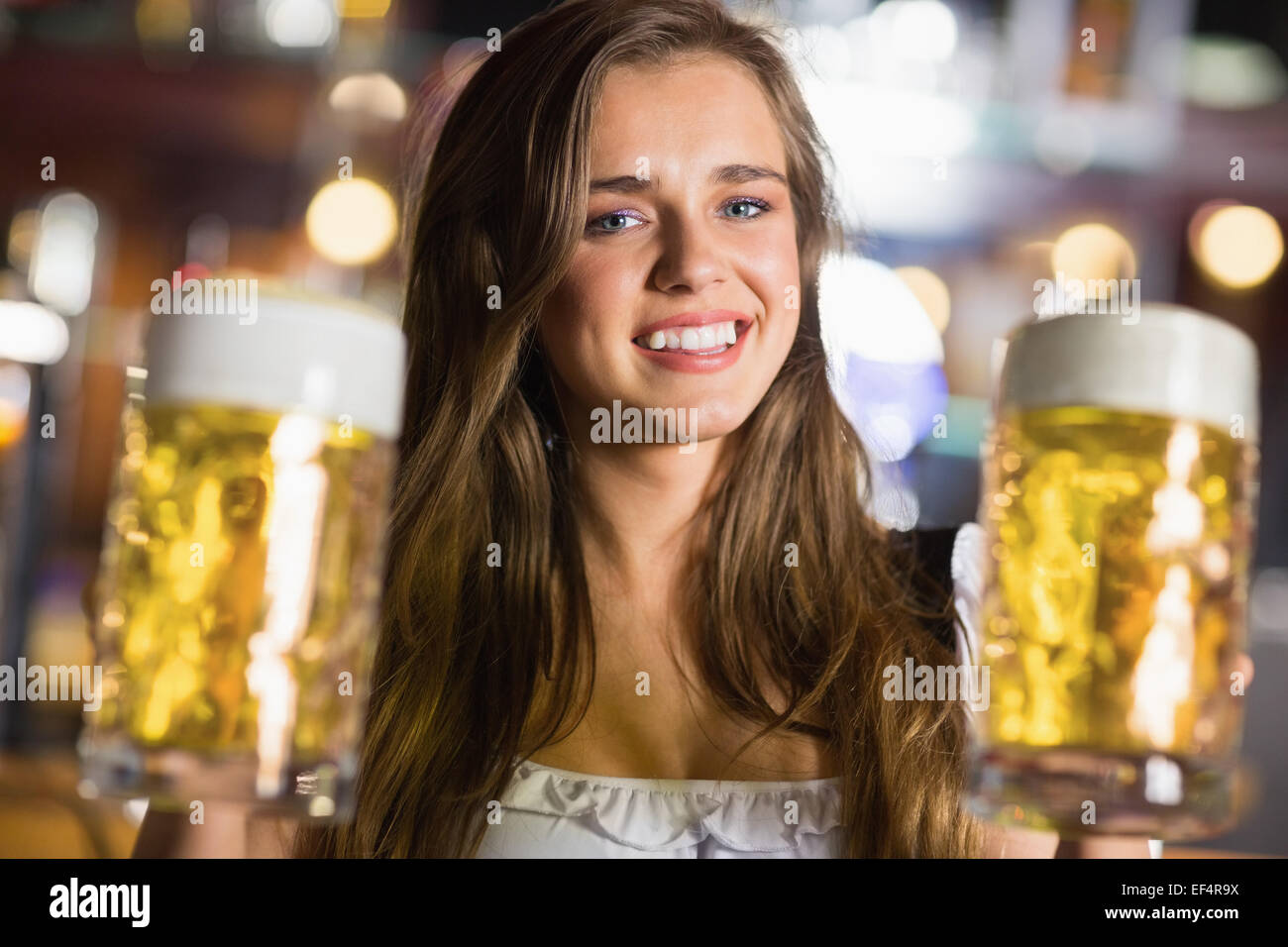 Smiling oktoberfest barmaid with beer Stock Photo - Alamy