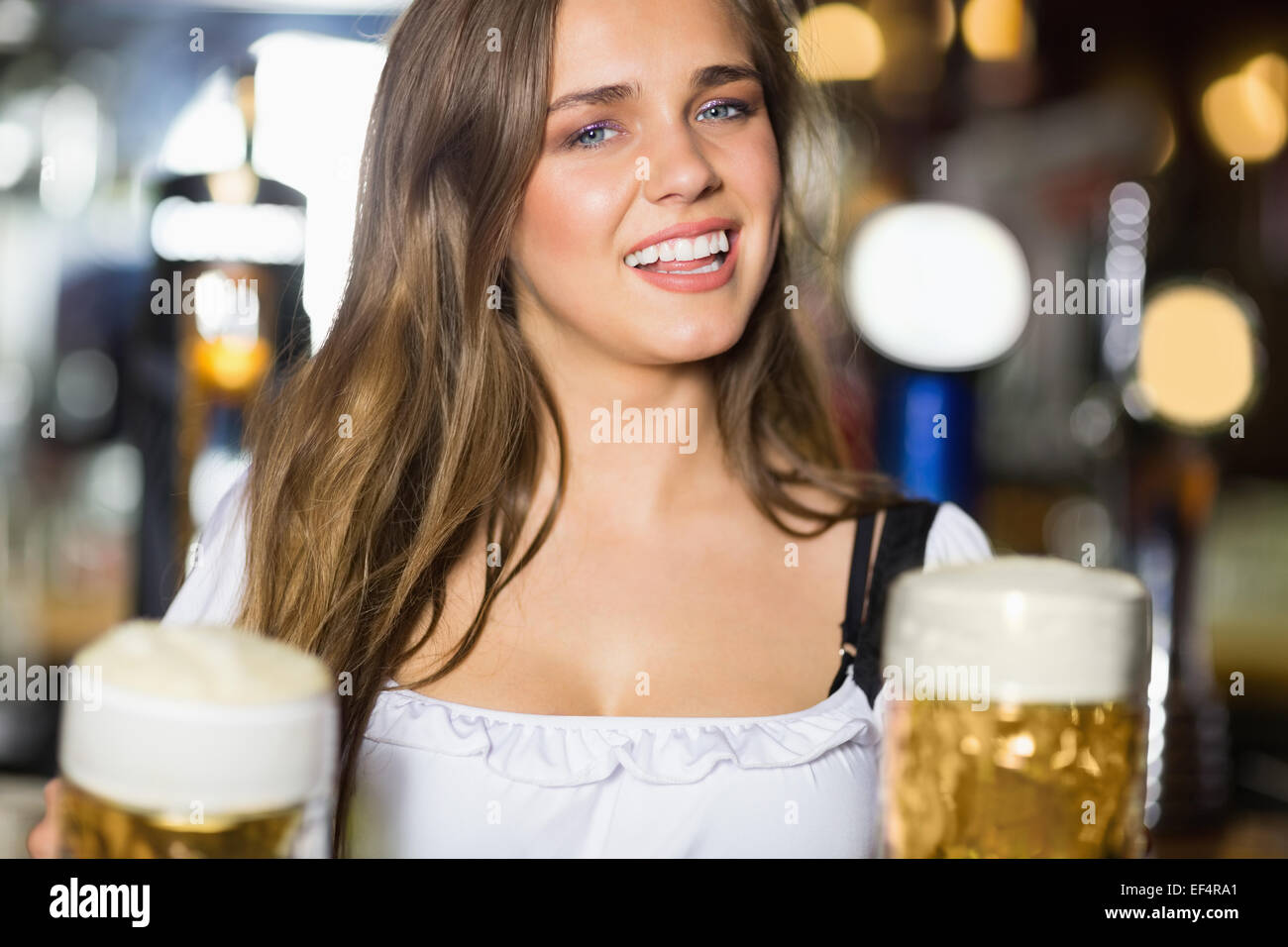 Smiling oktoberfest barmaid with beer Stock Photo - Alamy