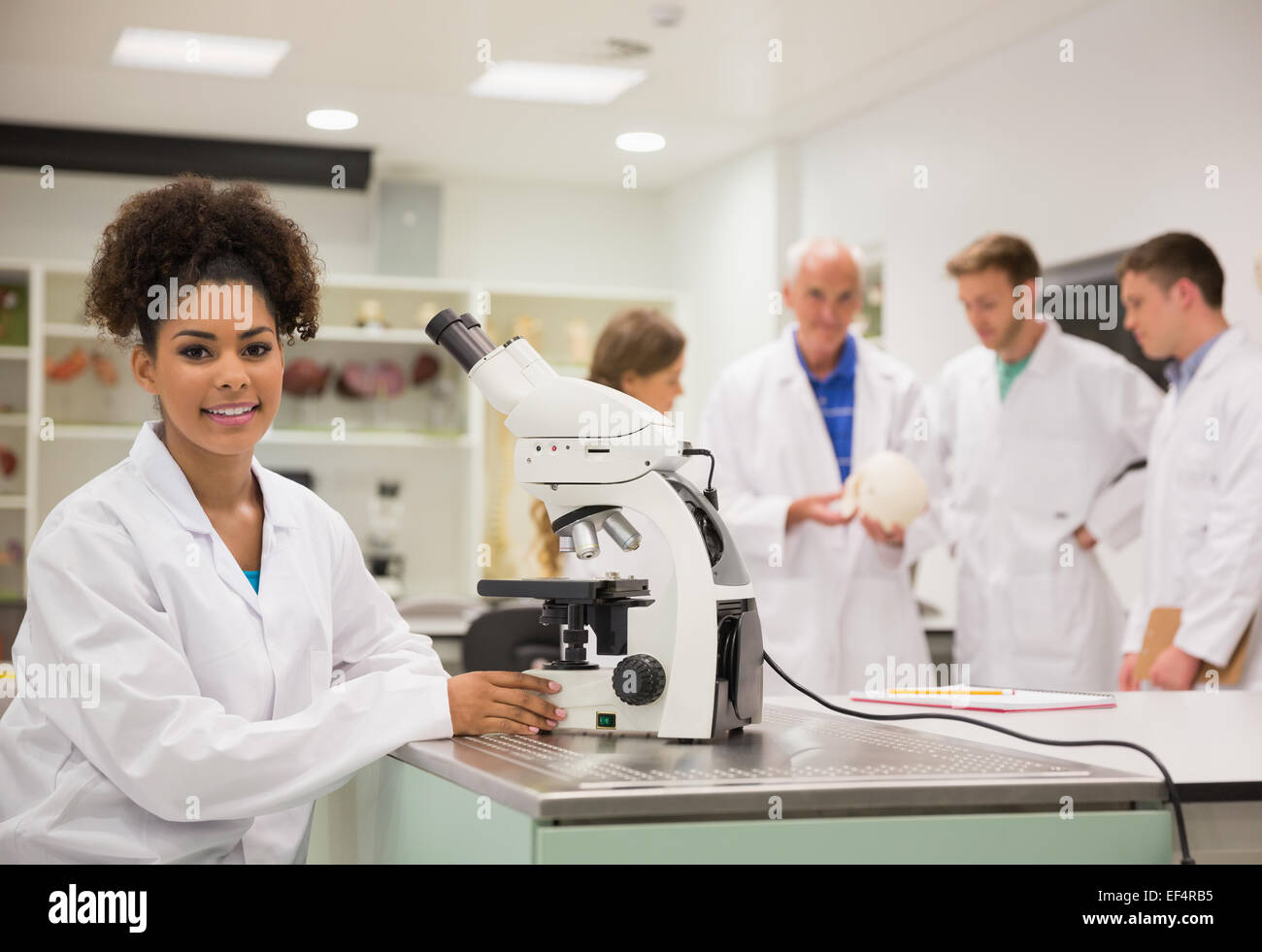 Happy medical student working with microscope Stock Photo - Alamy