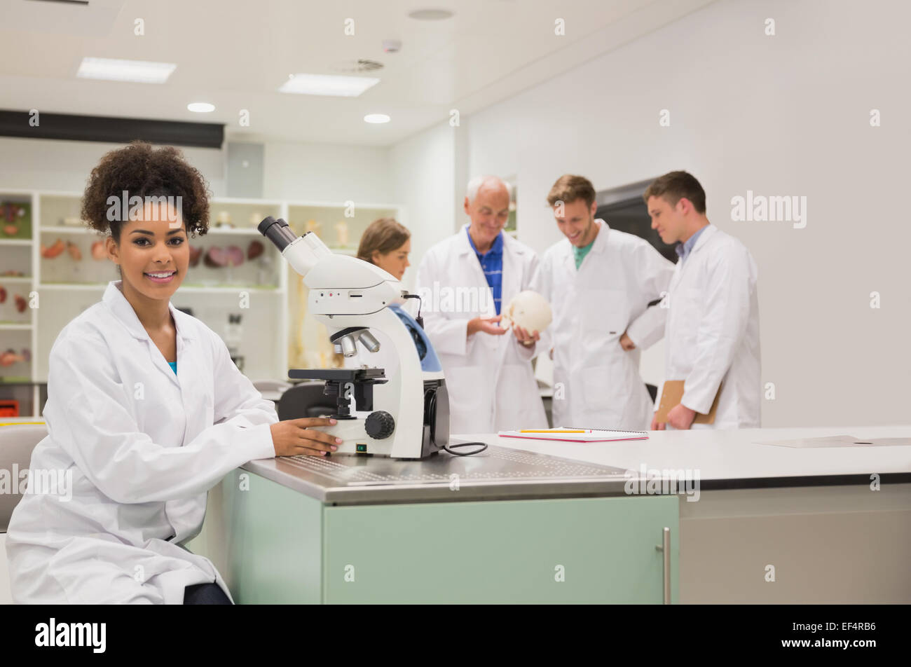Happy medical student working with microscope Stock Photo - Alamy