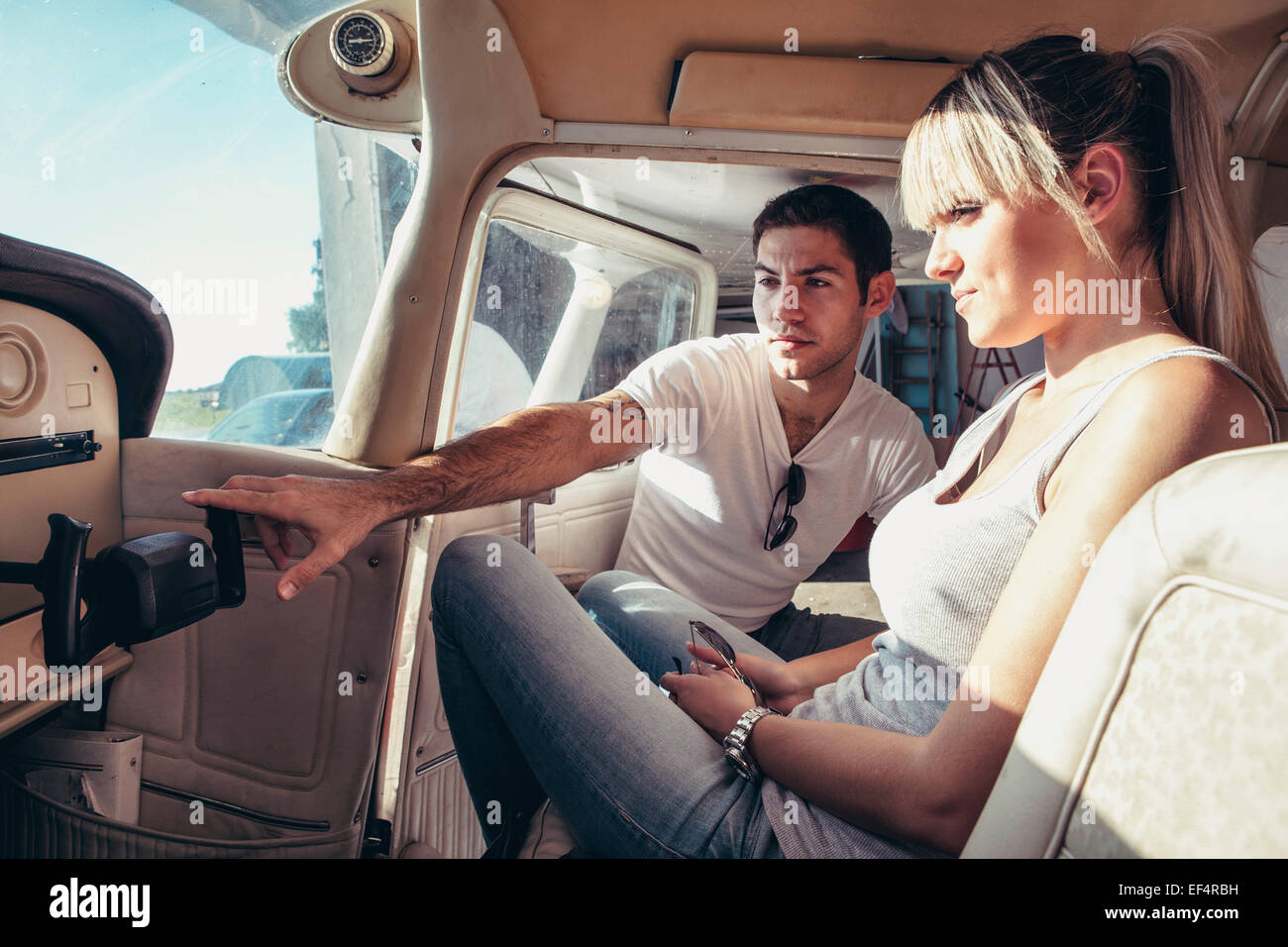 Young couple preparing for start in propeller airplane Stock Photo - Alamy