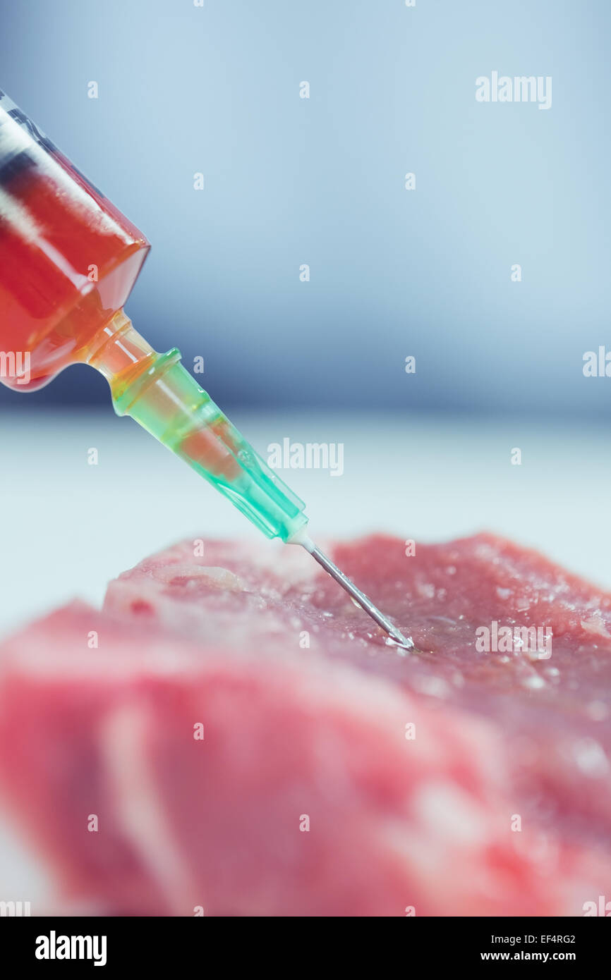 Food scientist injecting raw meat Stock Photo - Alamy