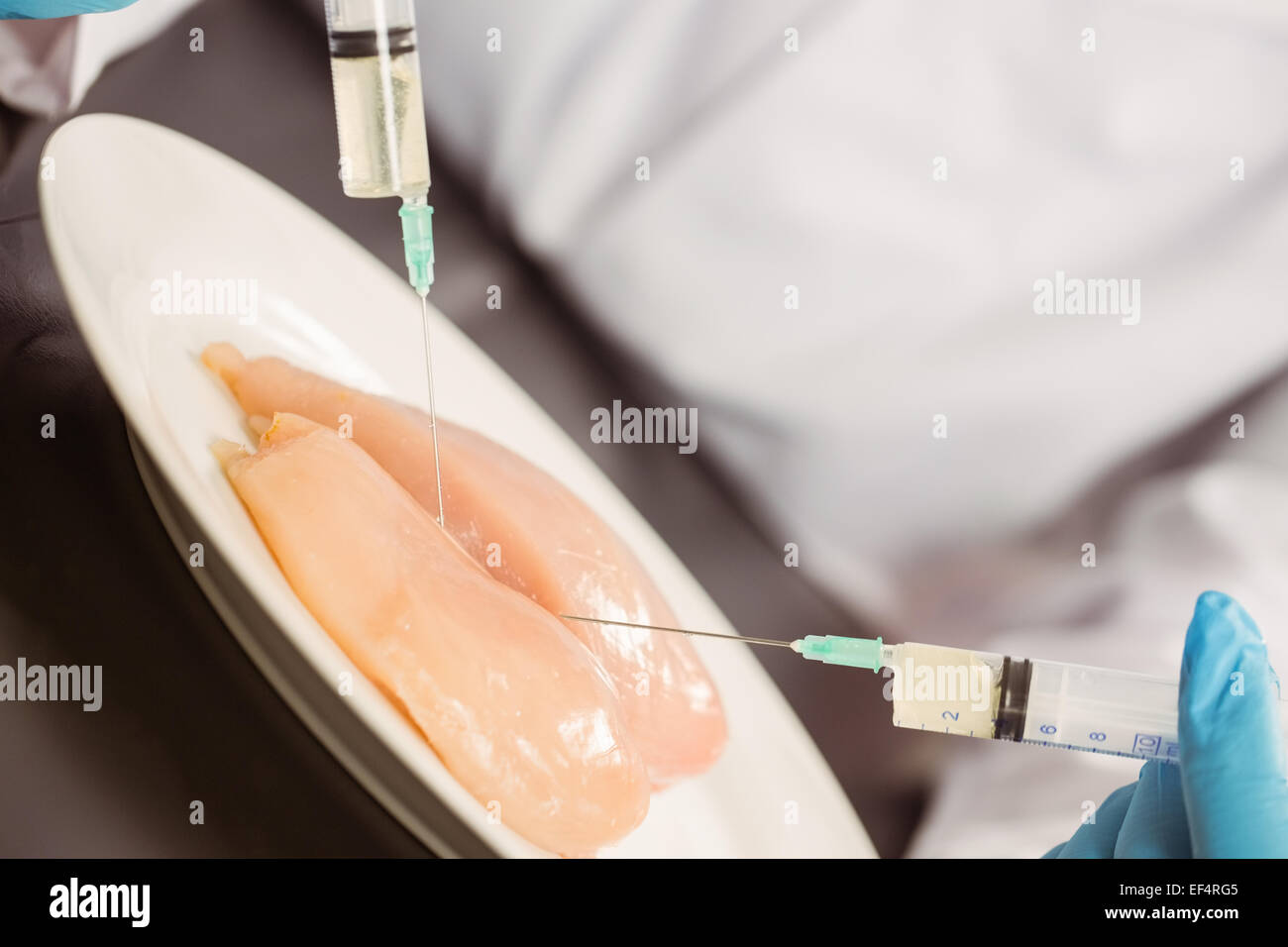 Food scientist injecting raw chicken Stock Photo - Alamy