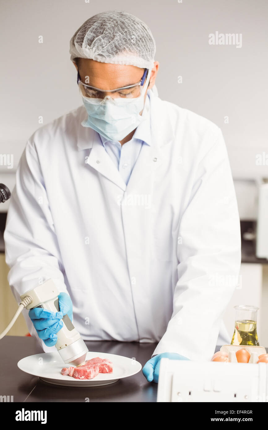 Food scientist using device on meat Stock Photo - Alamy