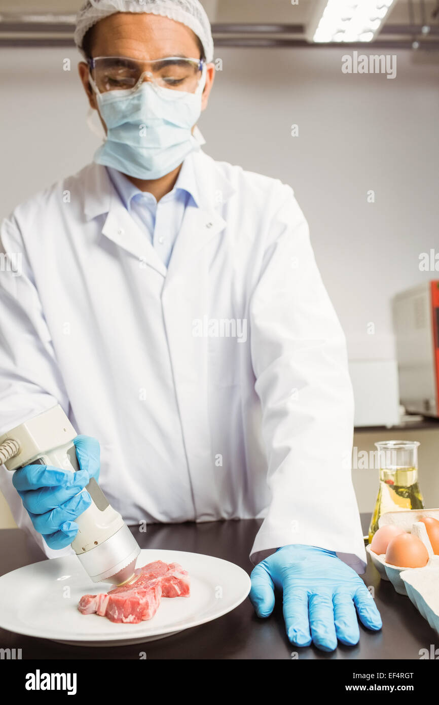 Food scientist using device on meat Stock Photo - Alamy