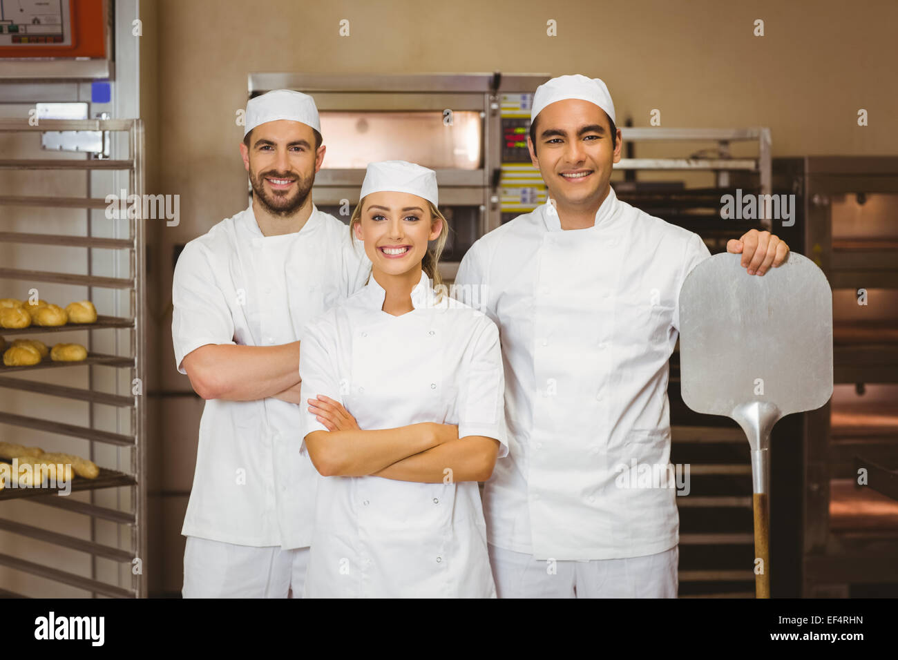 Team of bakers smiling at camera Stock Photo - Alamy