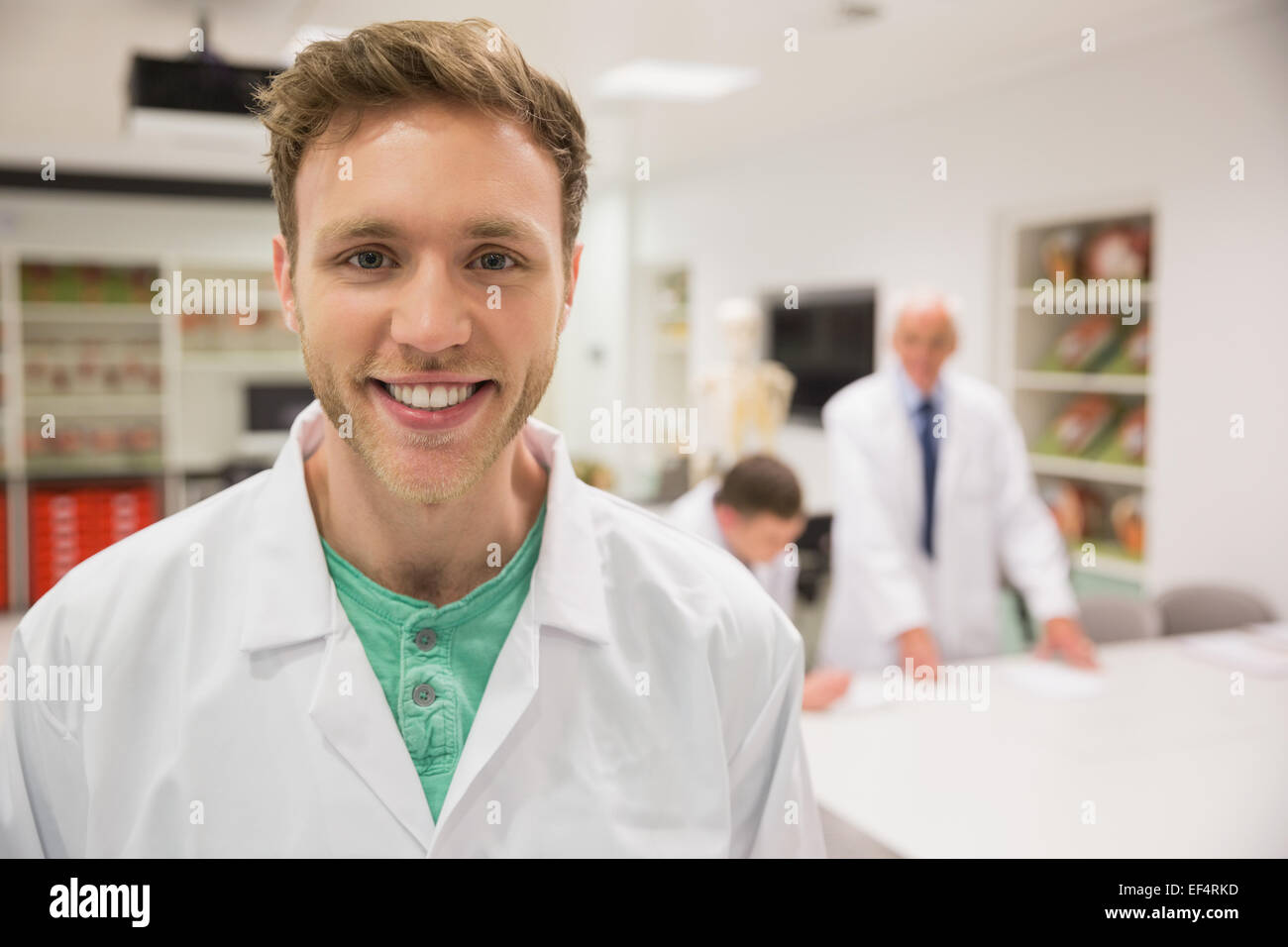 Handsome science student smiling at camera Stock Photo - Alamy
