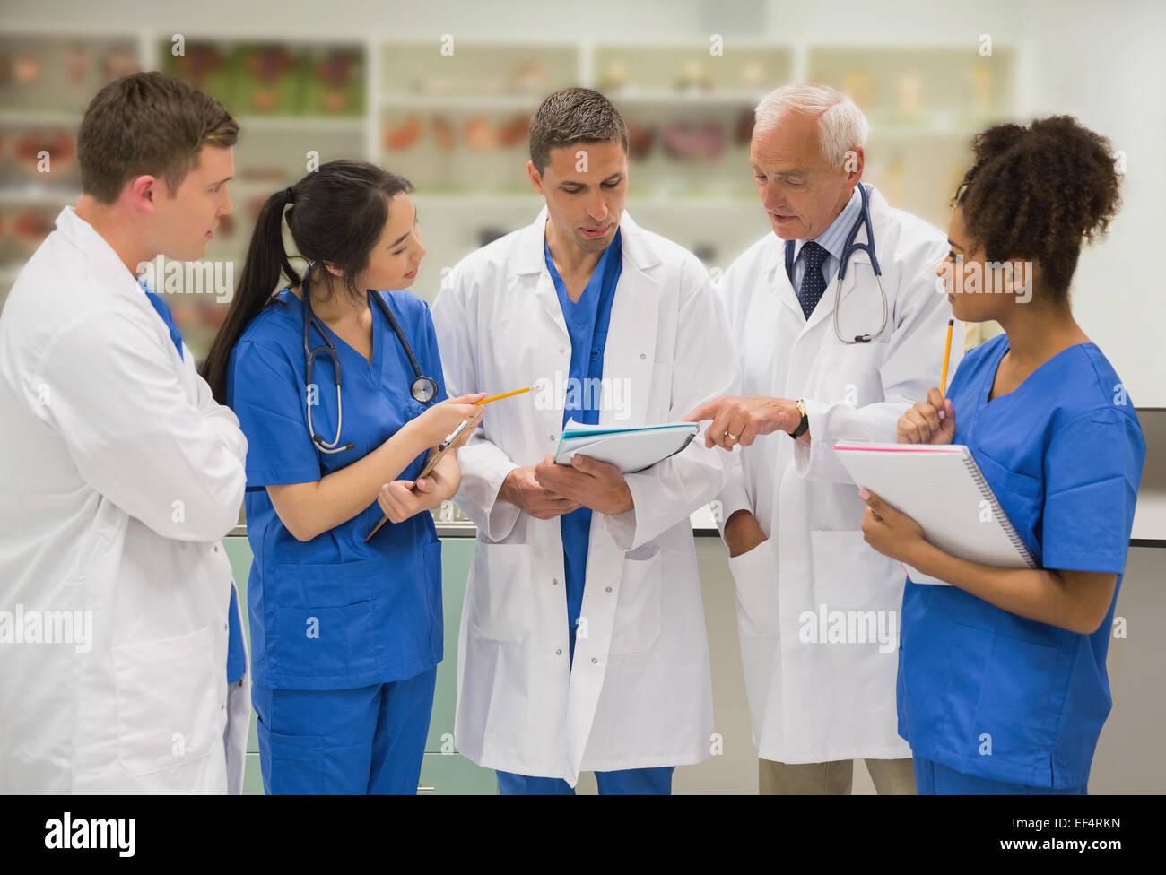 Medical professor talking with students Stock Photo - Alamy