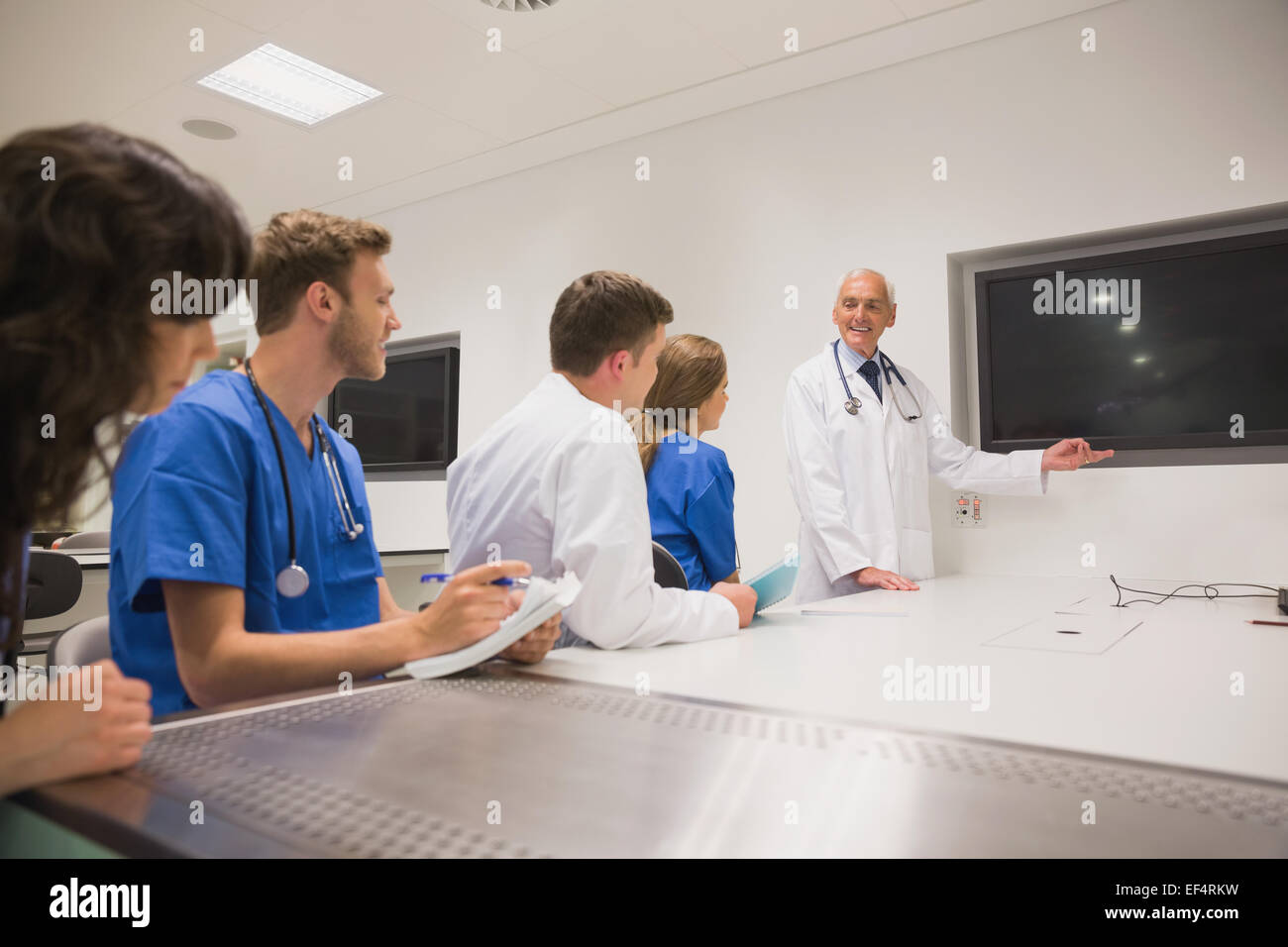 Medical professor teaching young students Stock Photo - Alamy