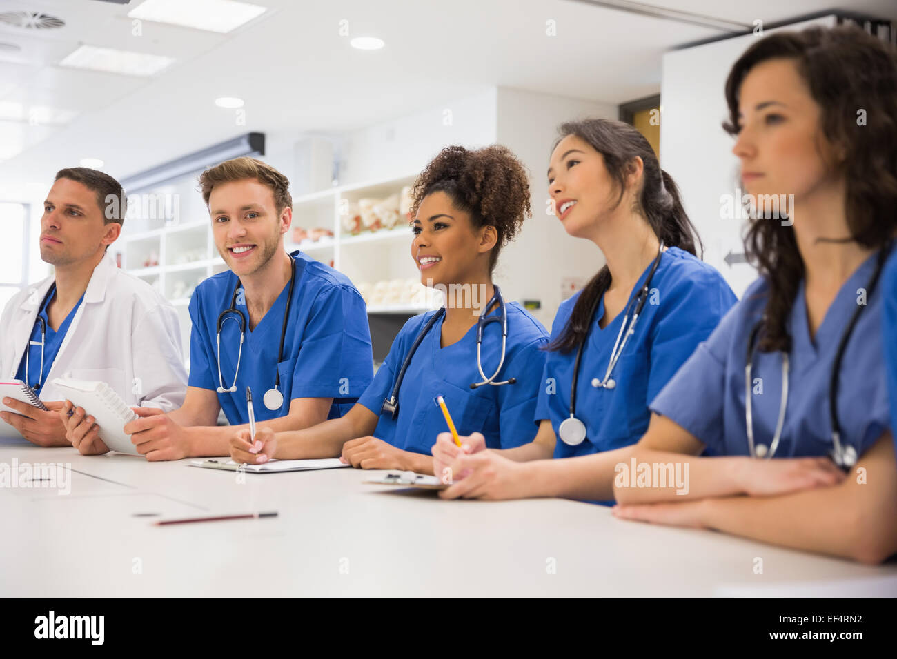 Medical student smiling at the camera during class Stock Photo - Alamy