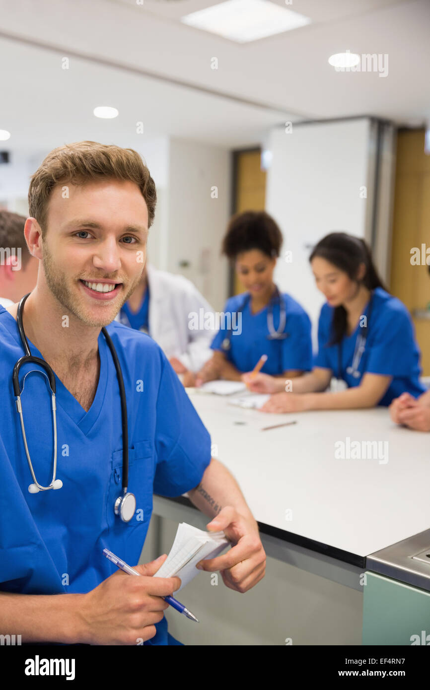 Medical student smiling at the camera during class Stock Photo - Alamy