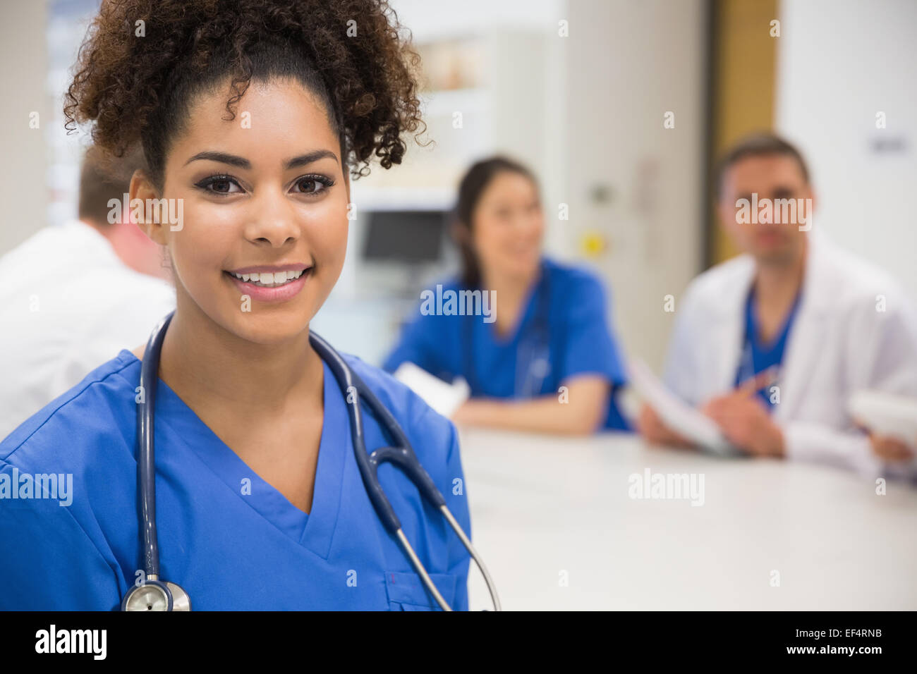 Medical student smiling at the camera during class Stock Photo - Alamy